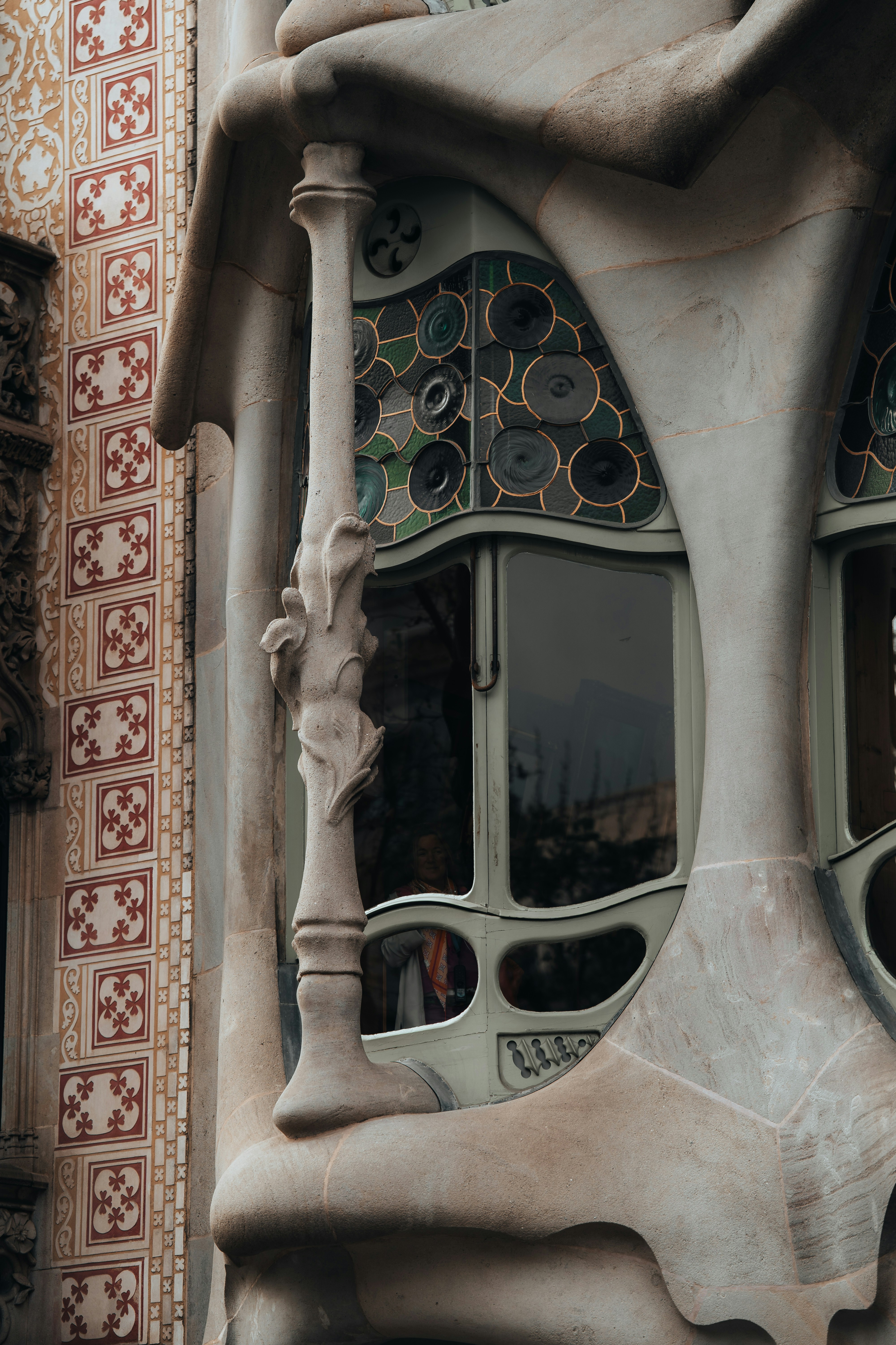 Intricate stone facade with organic curves and stained glass windows.