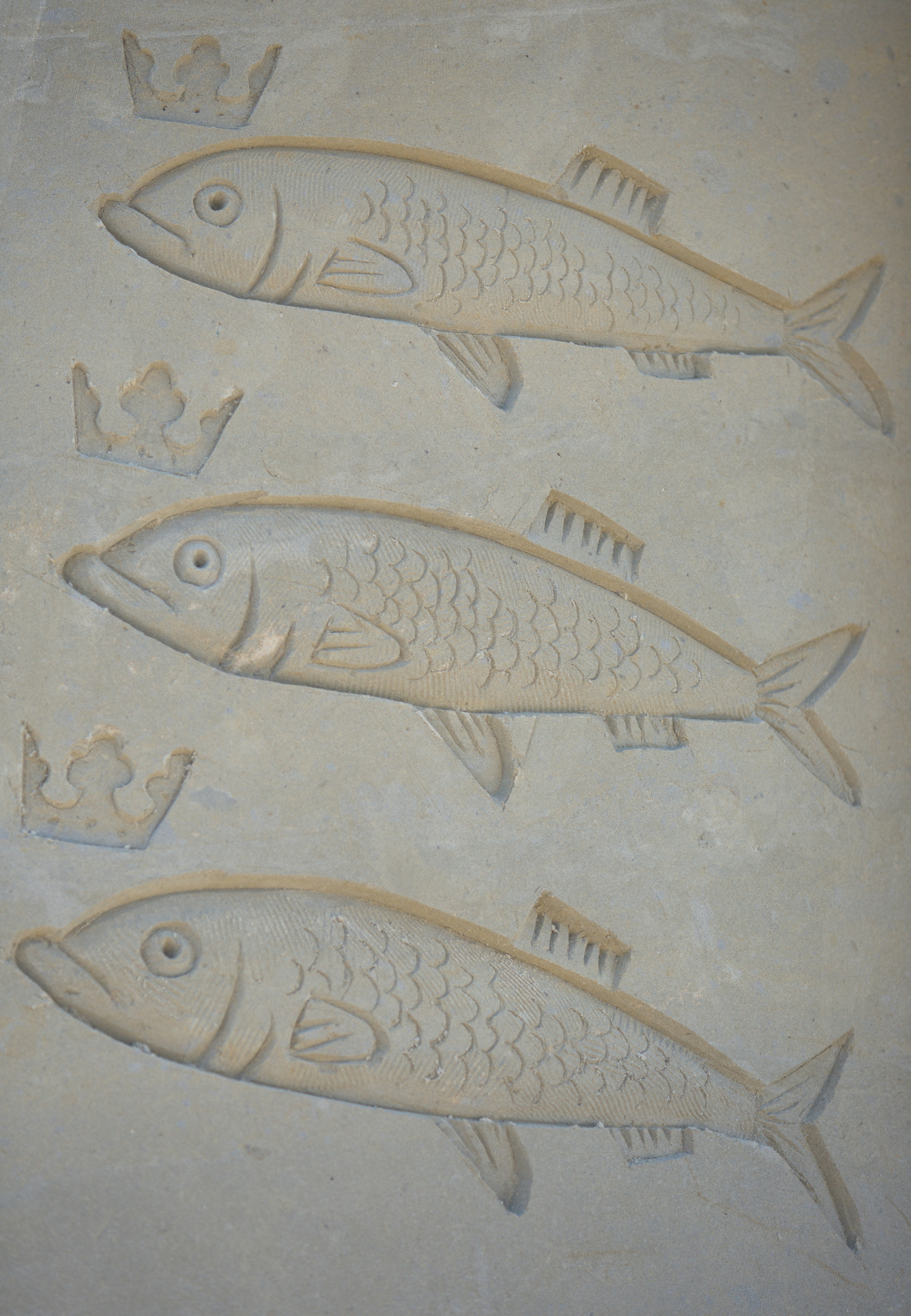 Crowned Carp Triad in Pale Stone Bas-Relief