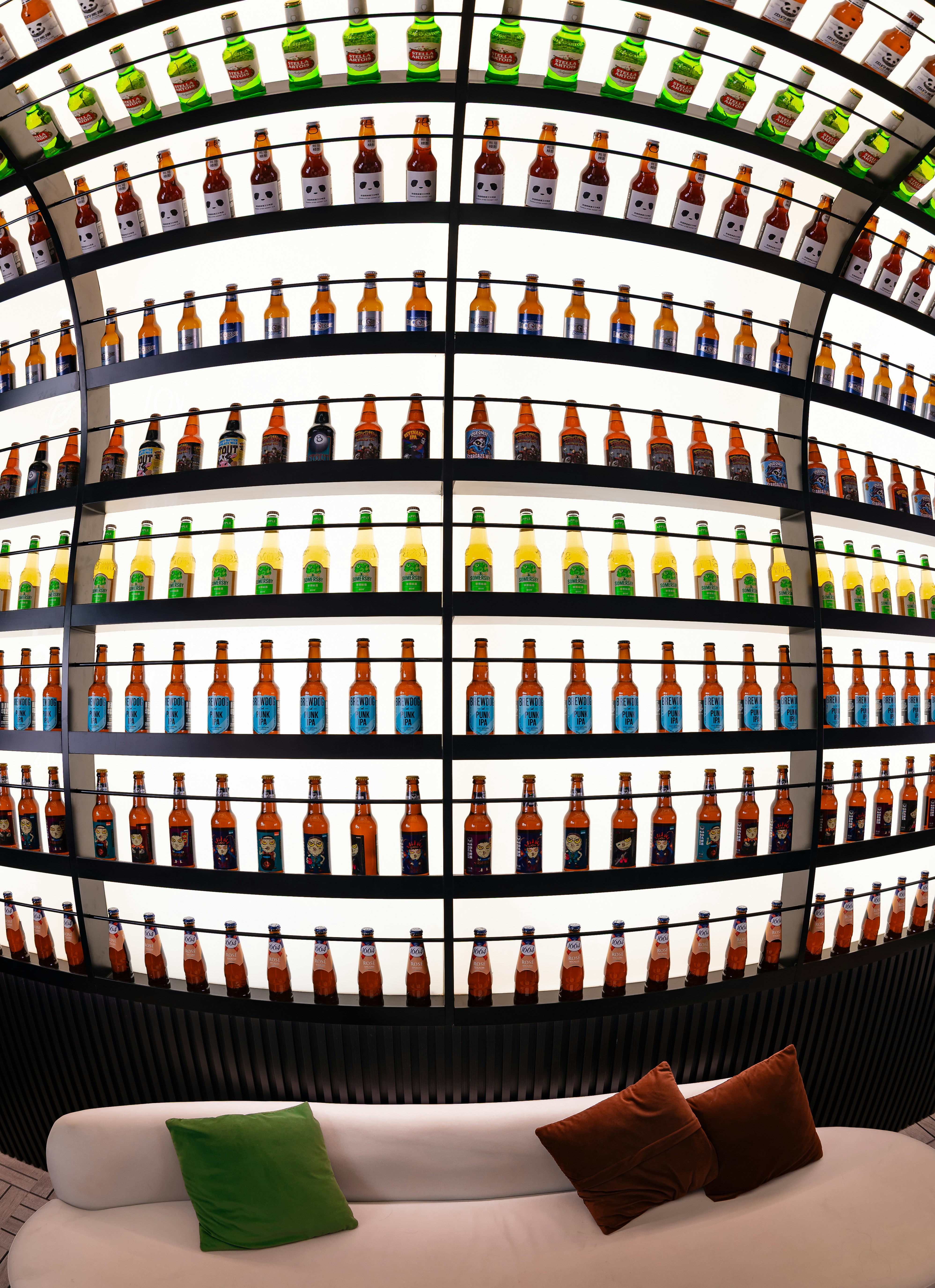Colorful Vertical Echo: Bottles Shelved in a Circular Gallery