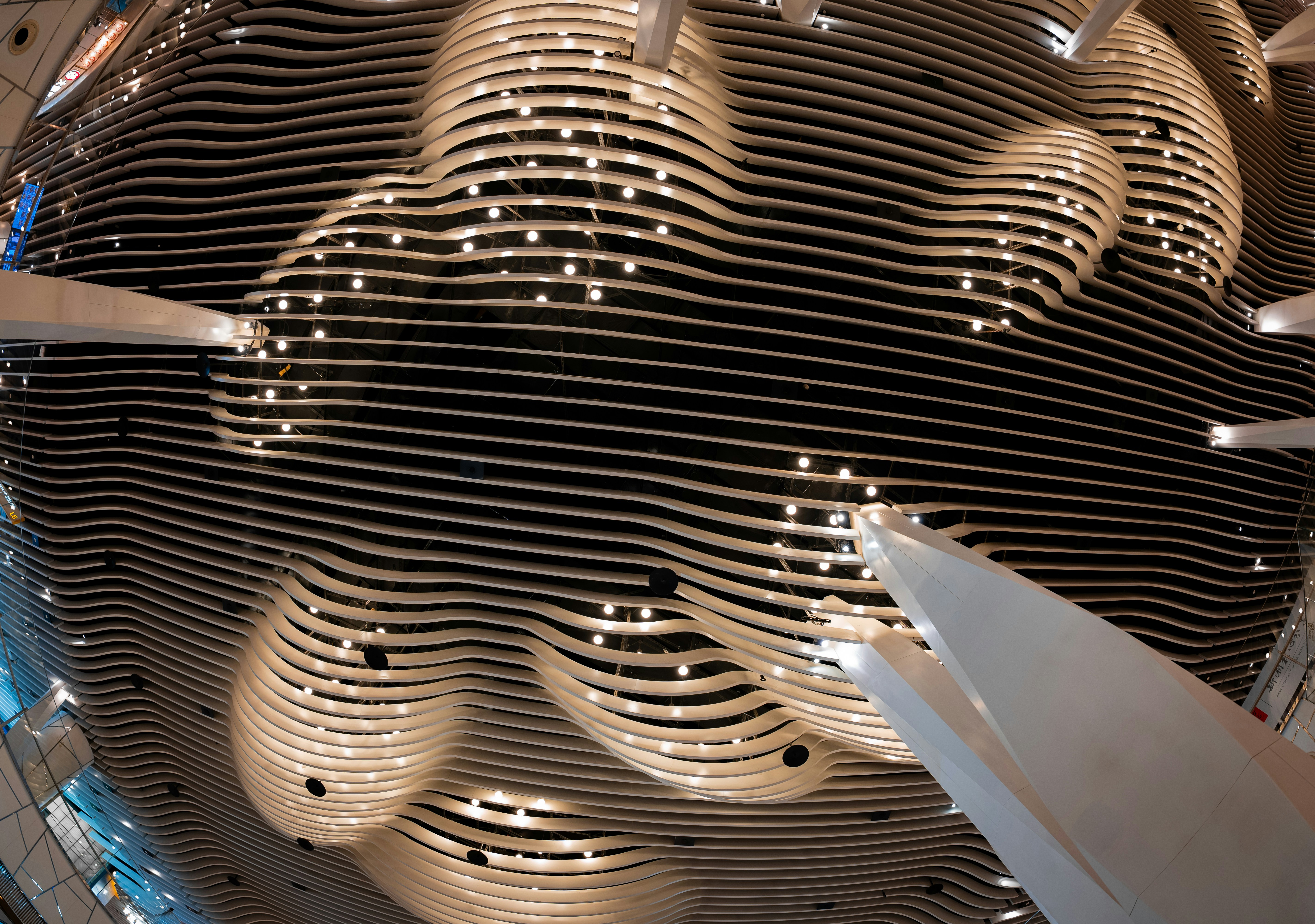 Harmonic Timber Waves: The Atrium's Layered Ceiling in Light