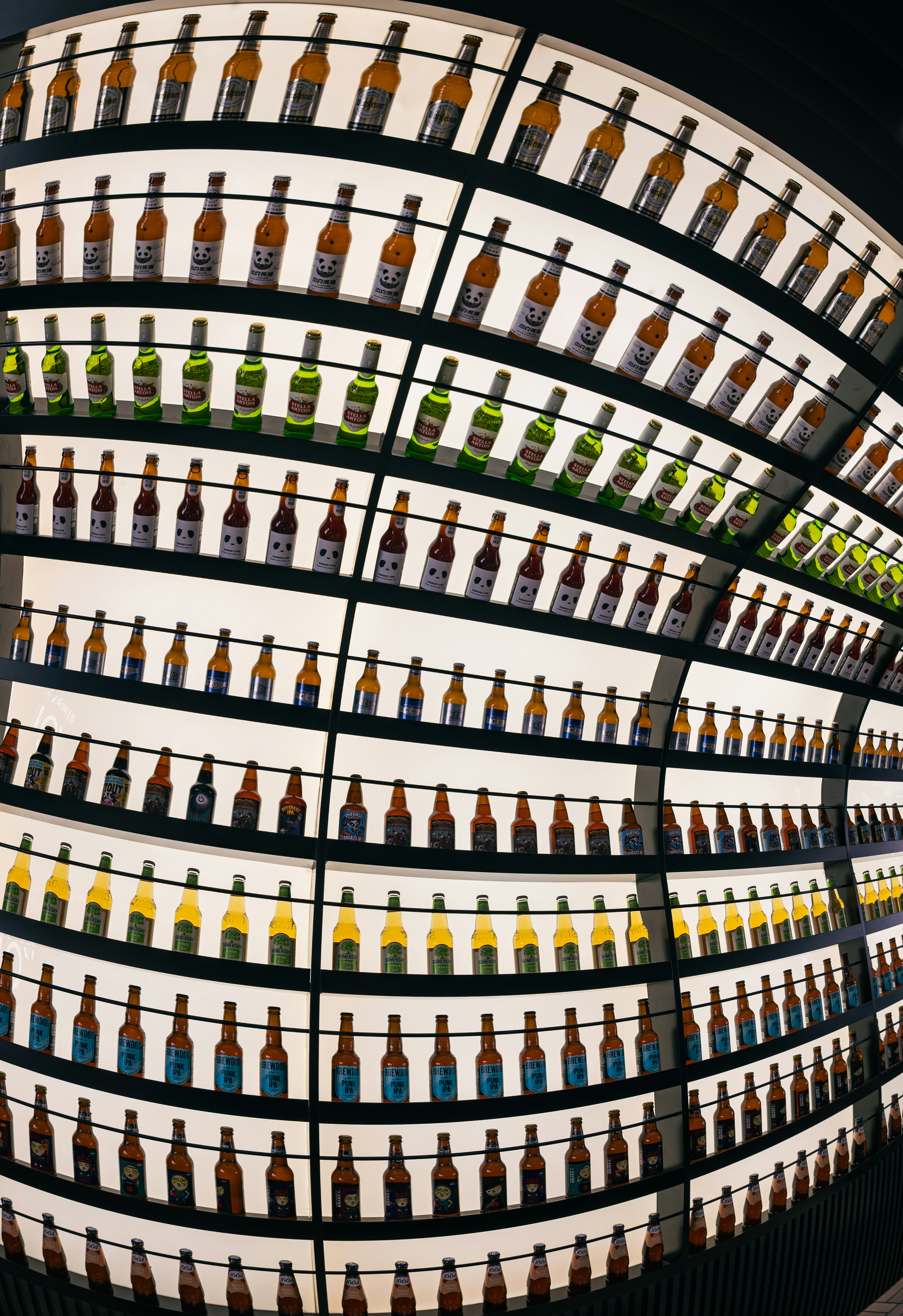 Curved Tiers of Bottles: A Kaleidoscope of Beverage Rows