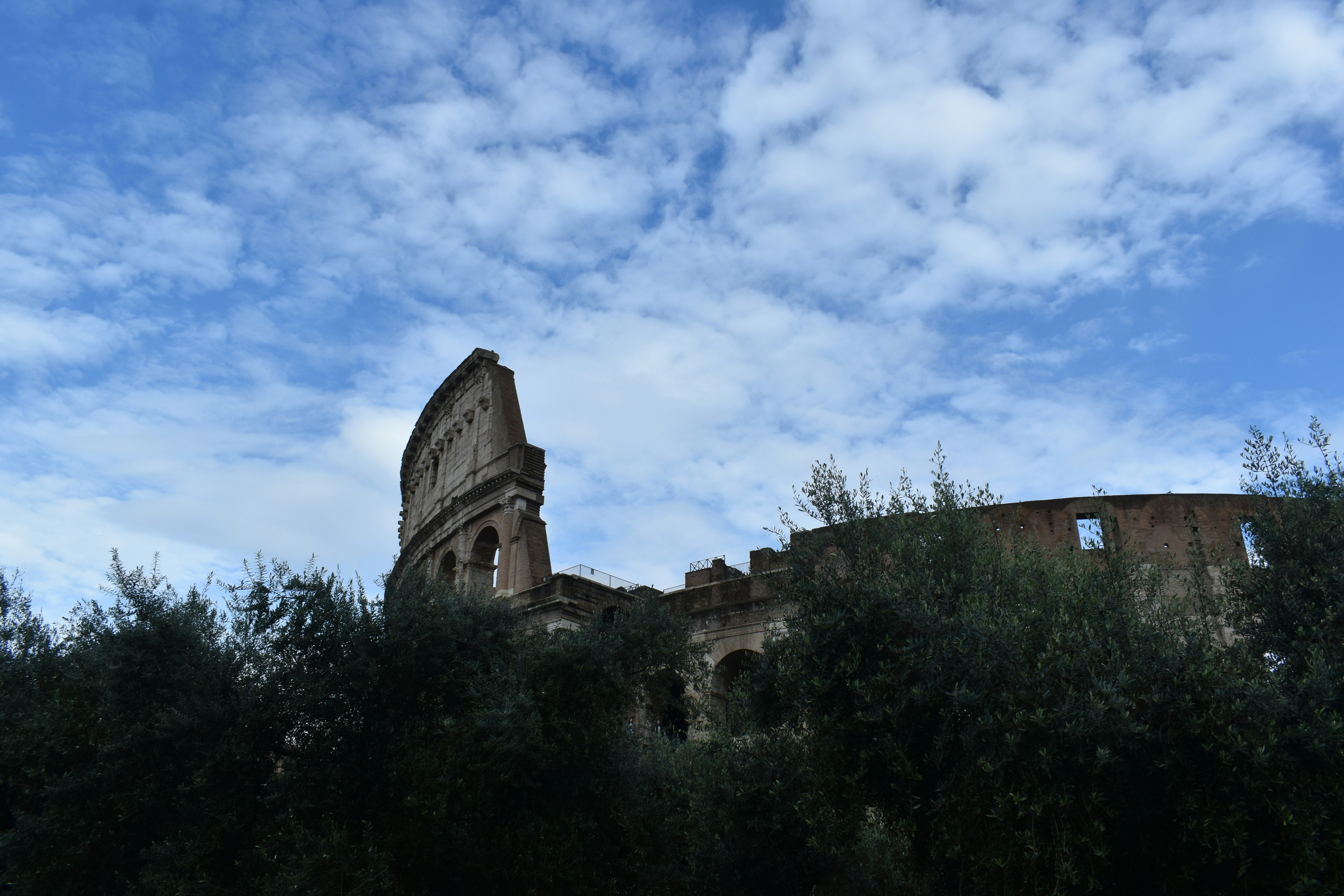 Skyward Archway Overgrown: Ruins Framed by a Clear Blue Sky