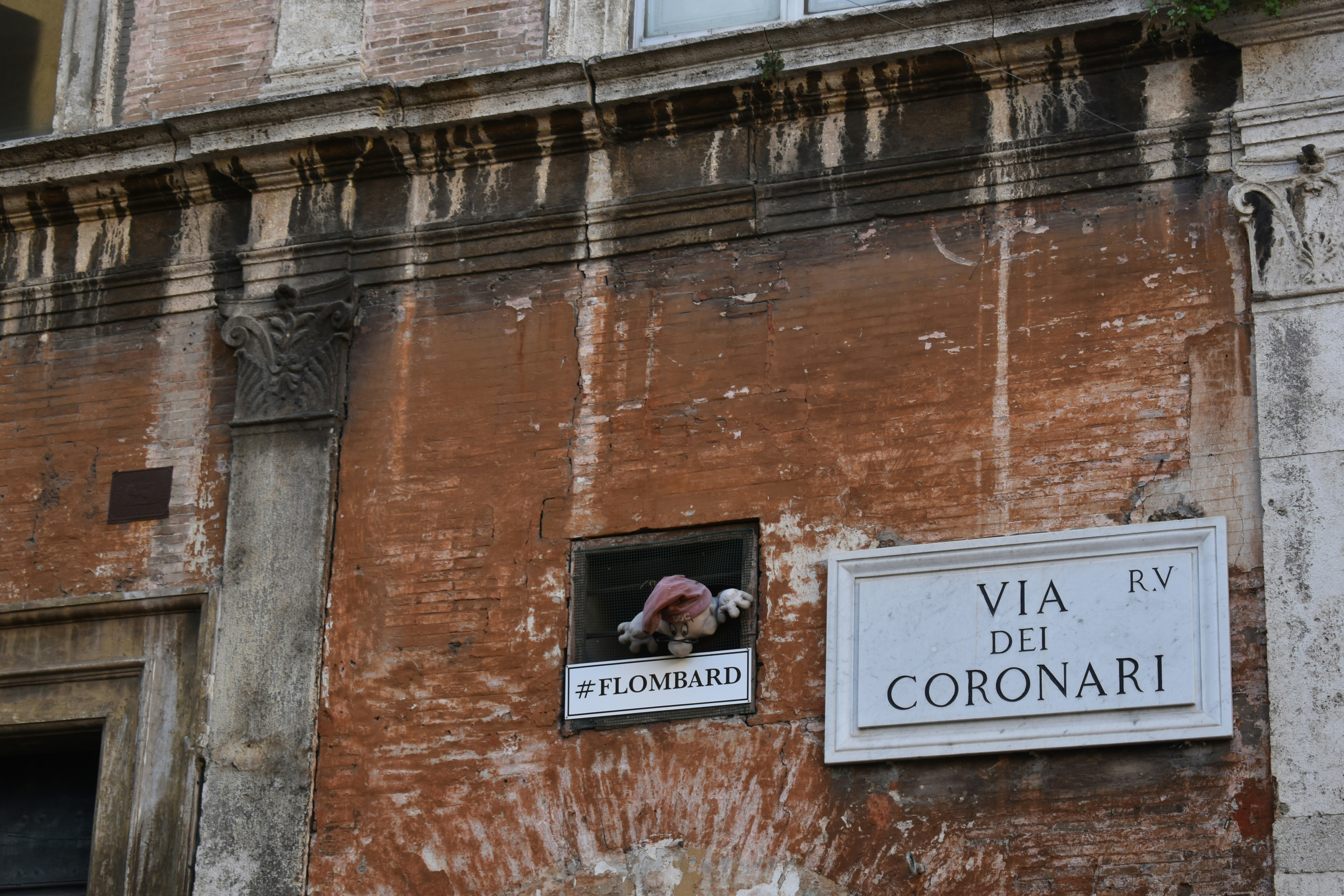 Rome street | A person leans out of a window in rome.