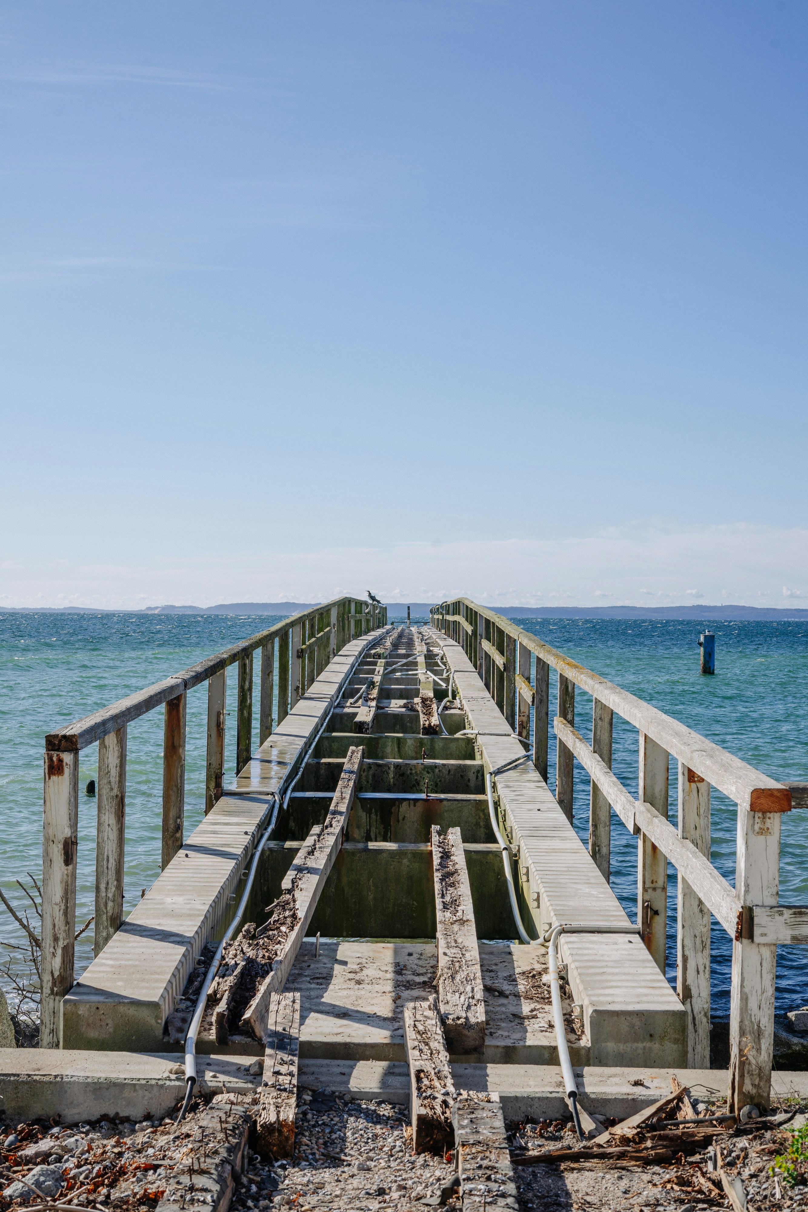 Broken pier stretches toward the ocean.