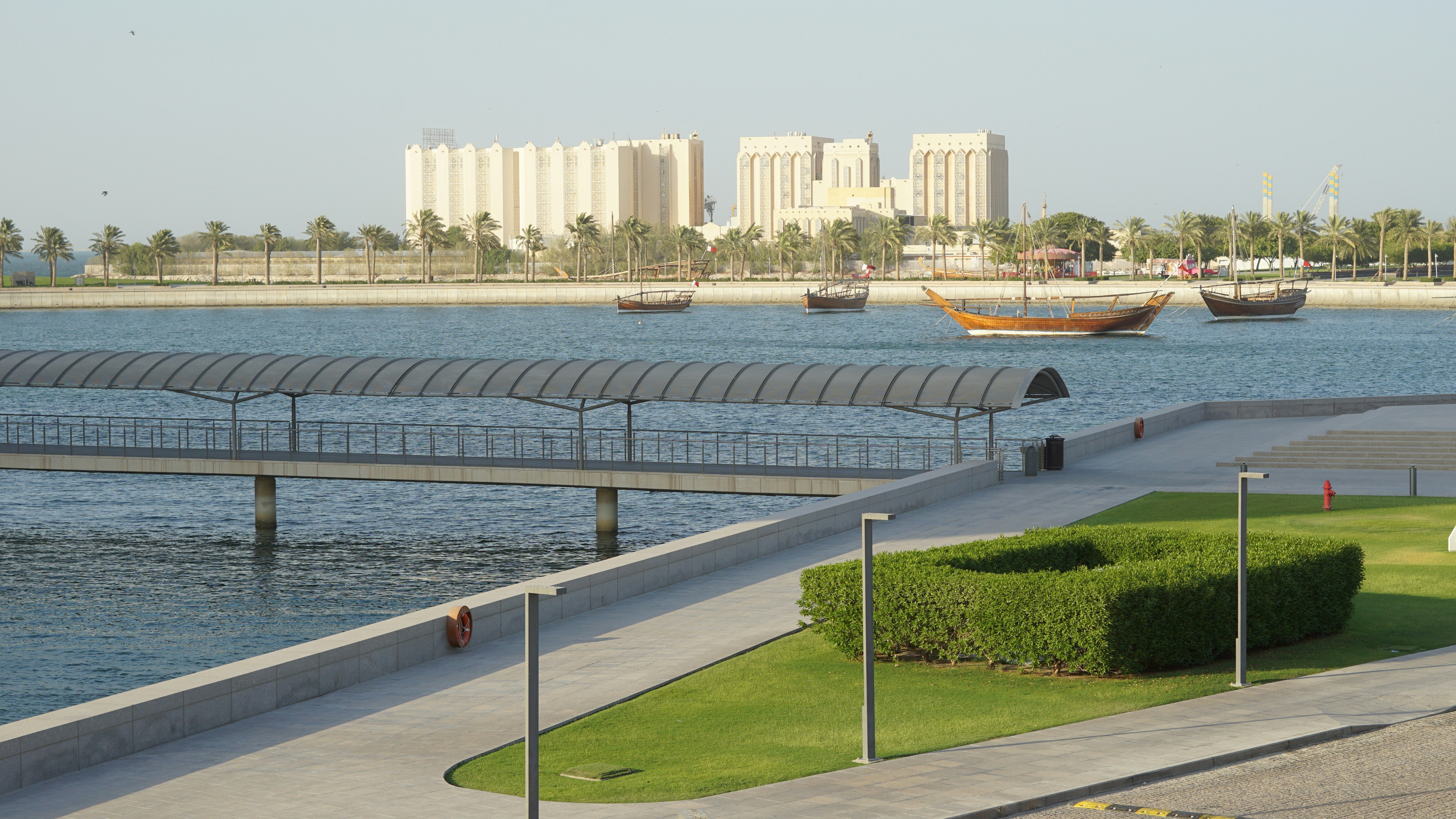 Harbor Promenade: Boats Punctuate a Calm Waterfront with a City Skyline