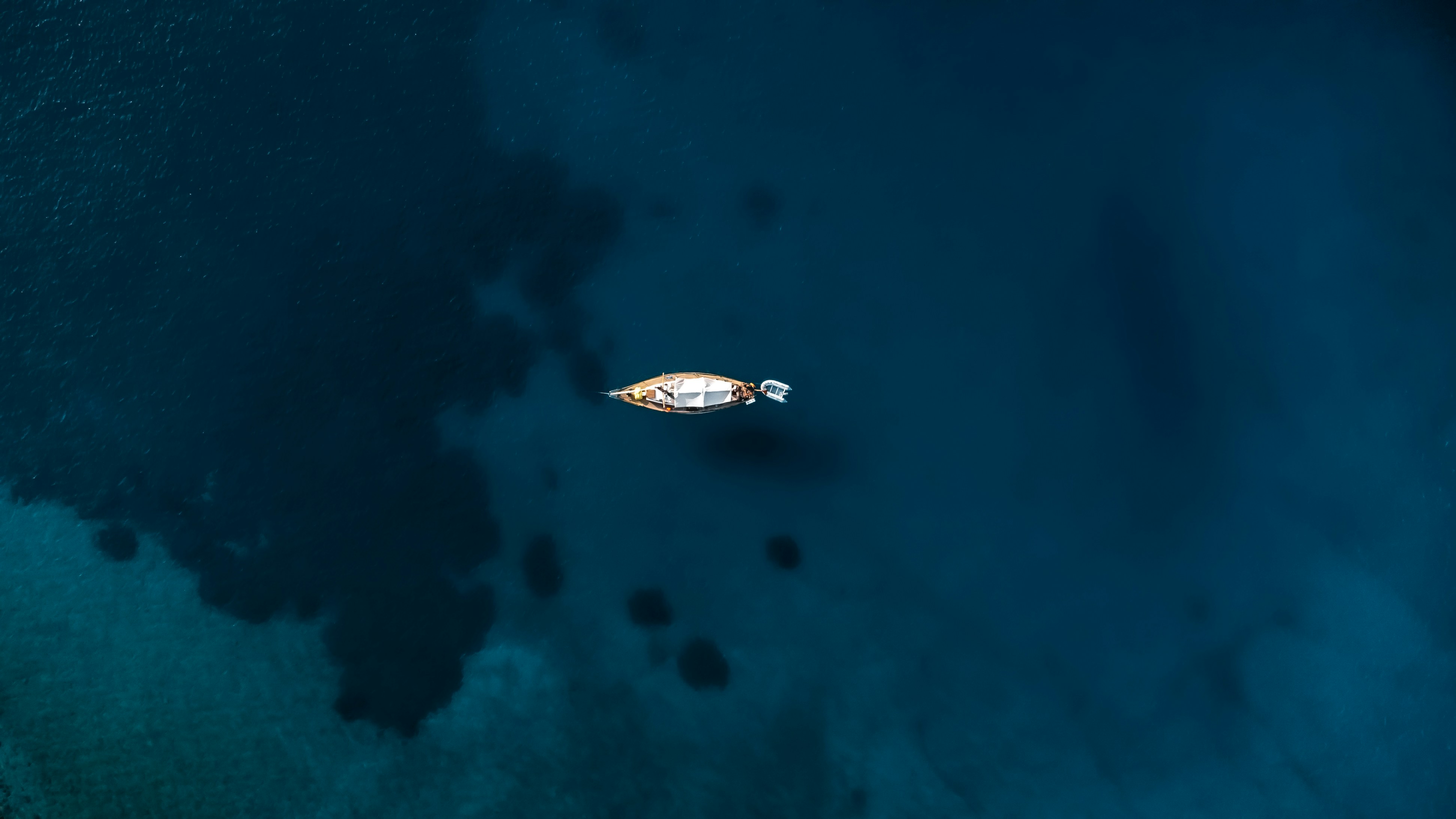 A ship floats alone on the deep, blue water. photo – Free Sea Image on ...