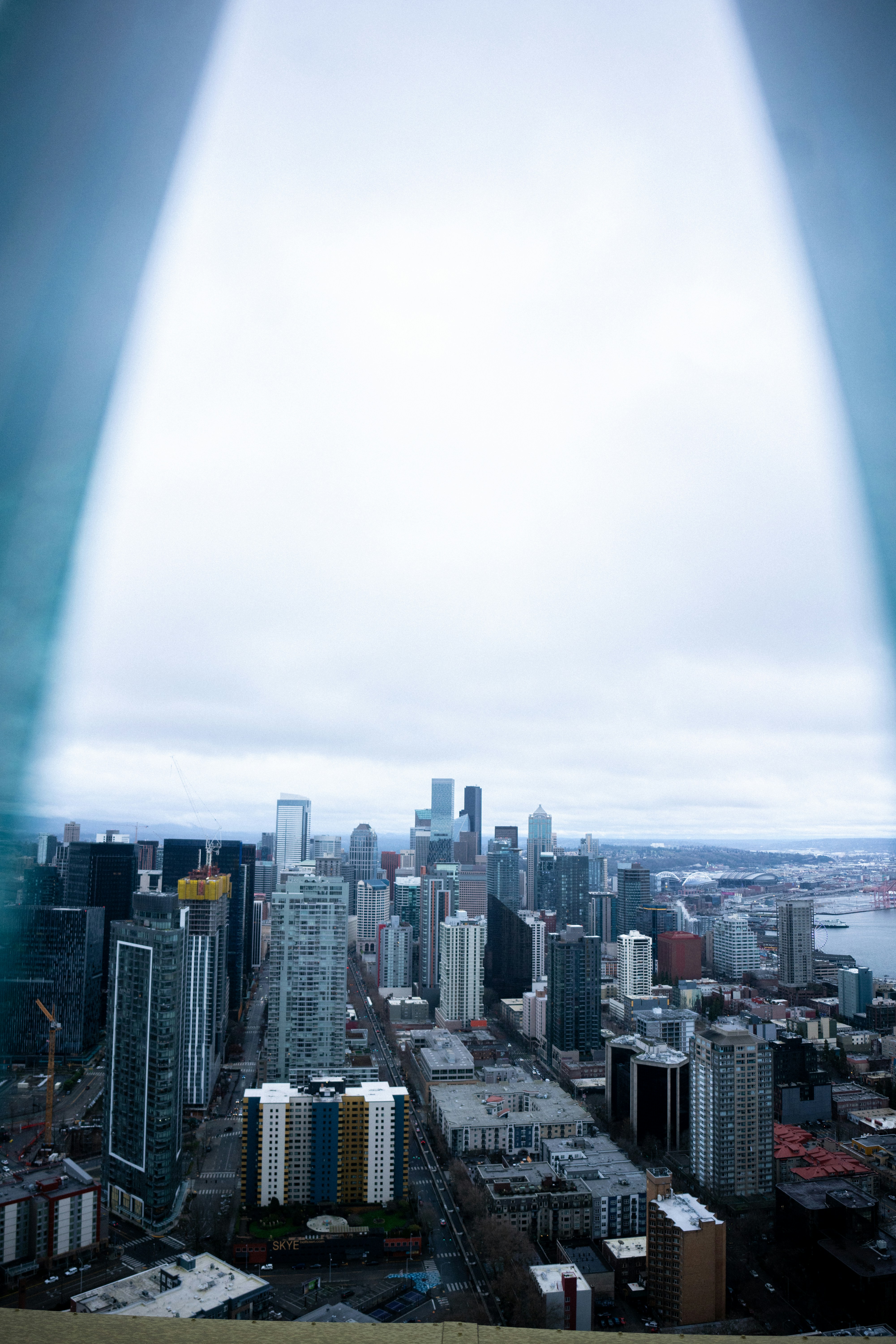 City skyline beneath a dramatic, bright beam from the sky on a cloudy day.