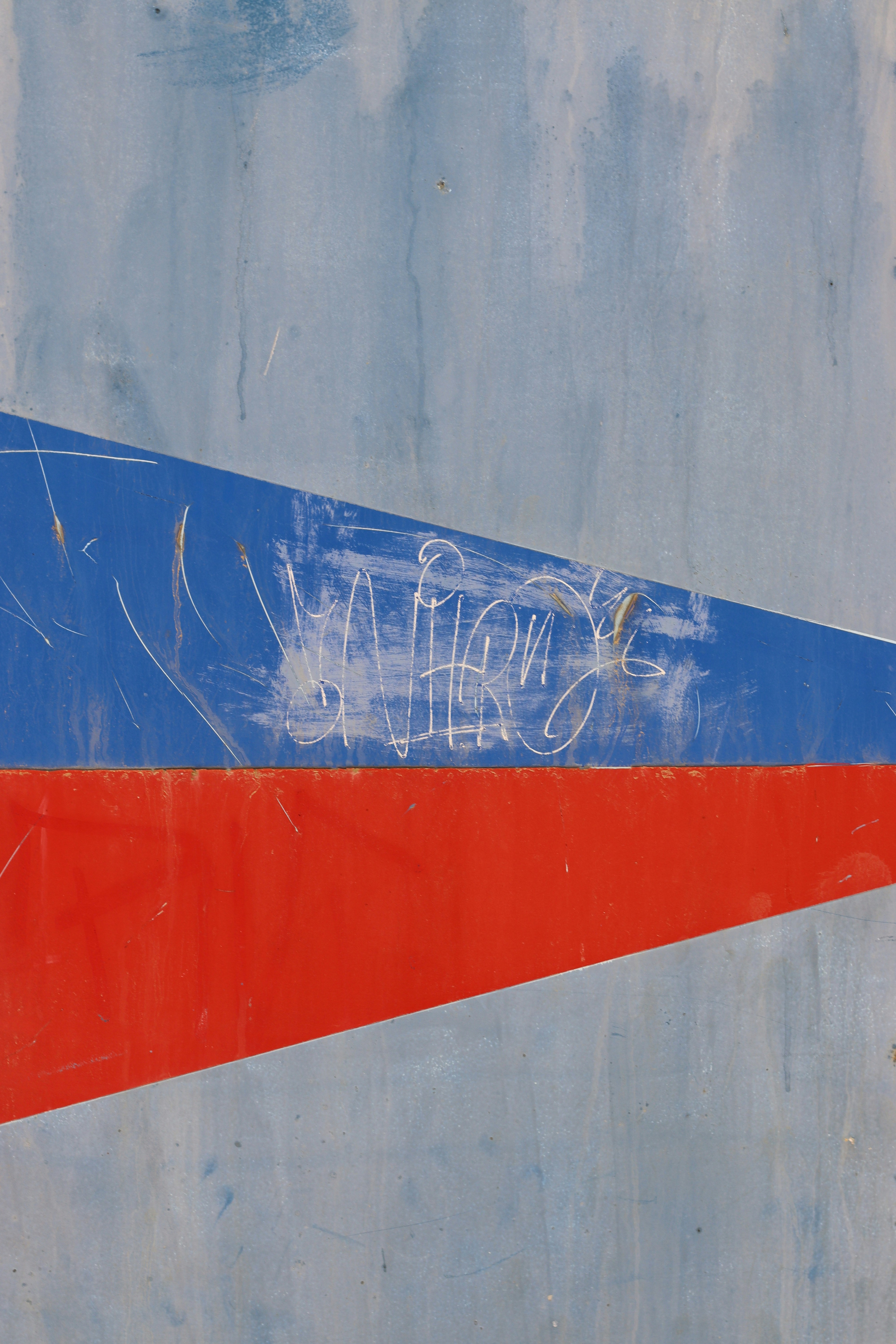 Diagonal Stripes: Graffiti and Rust on a Weathered Wall