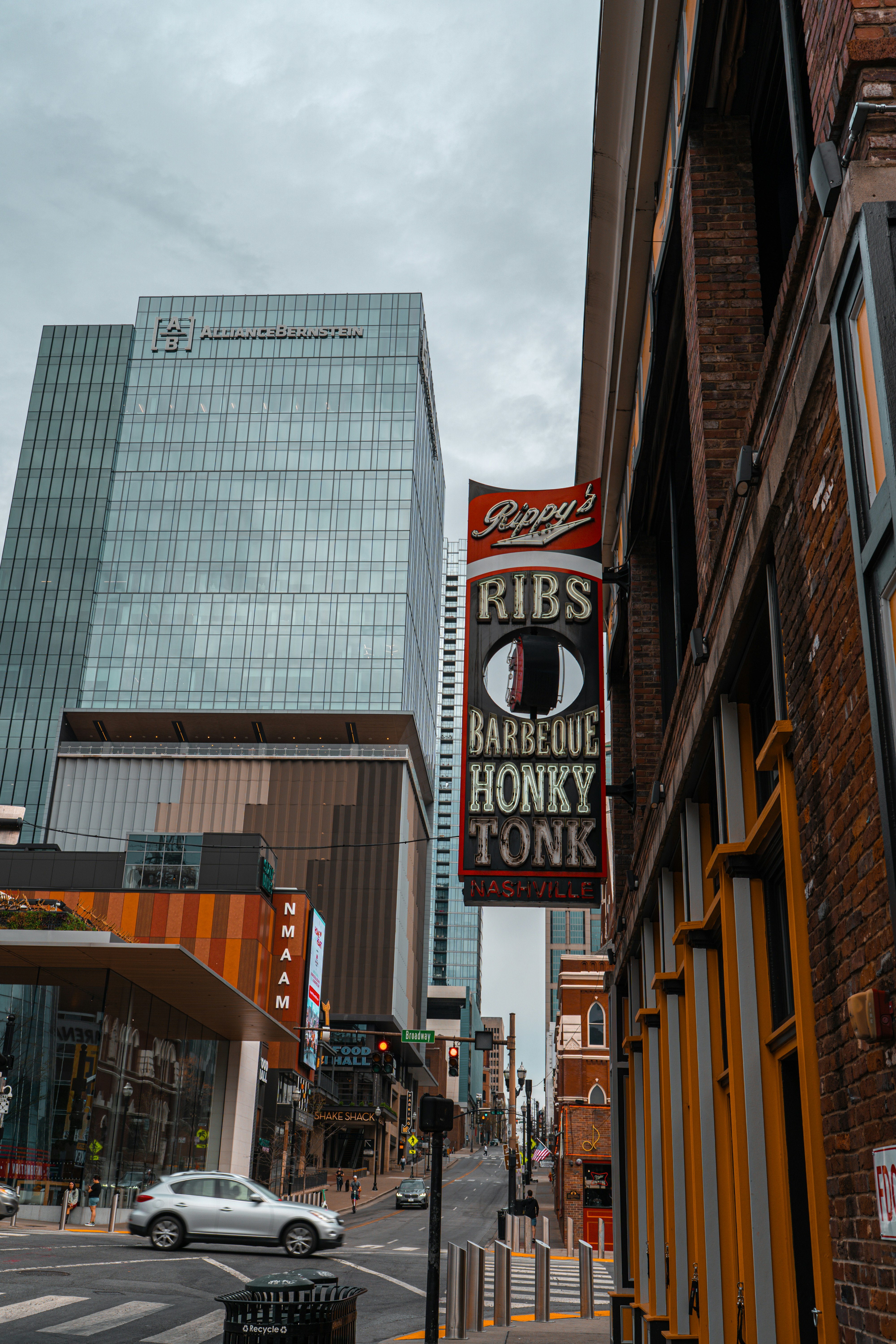 RIBS Barbecue Neon: A Nashville Street Sign Between Glass Tower and Brick Facades