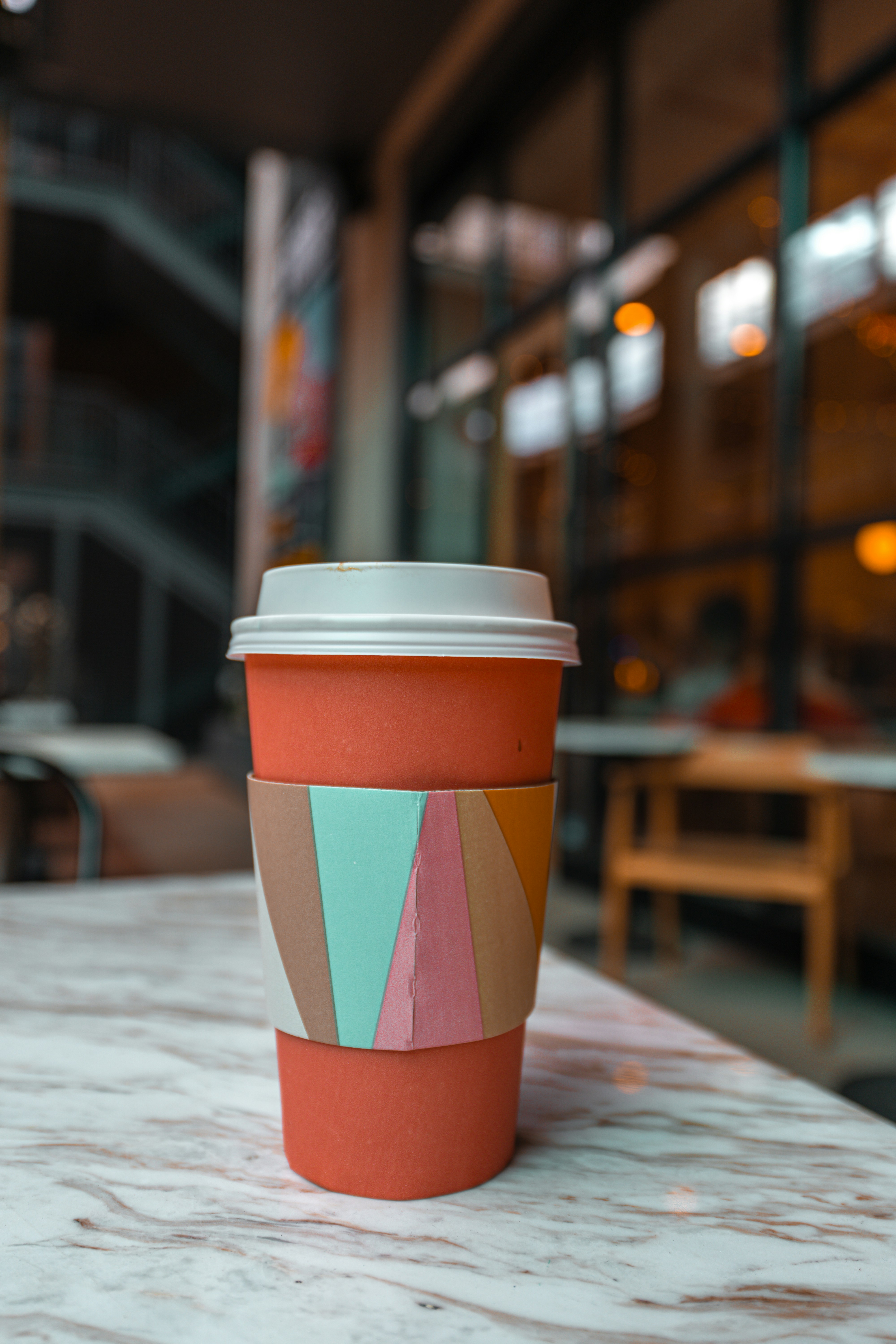 Urban Café Geometry: Colorful Sleeve on Marble Table
