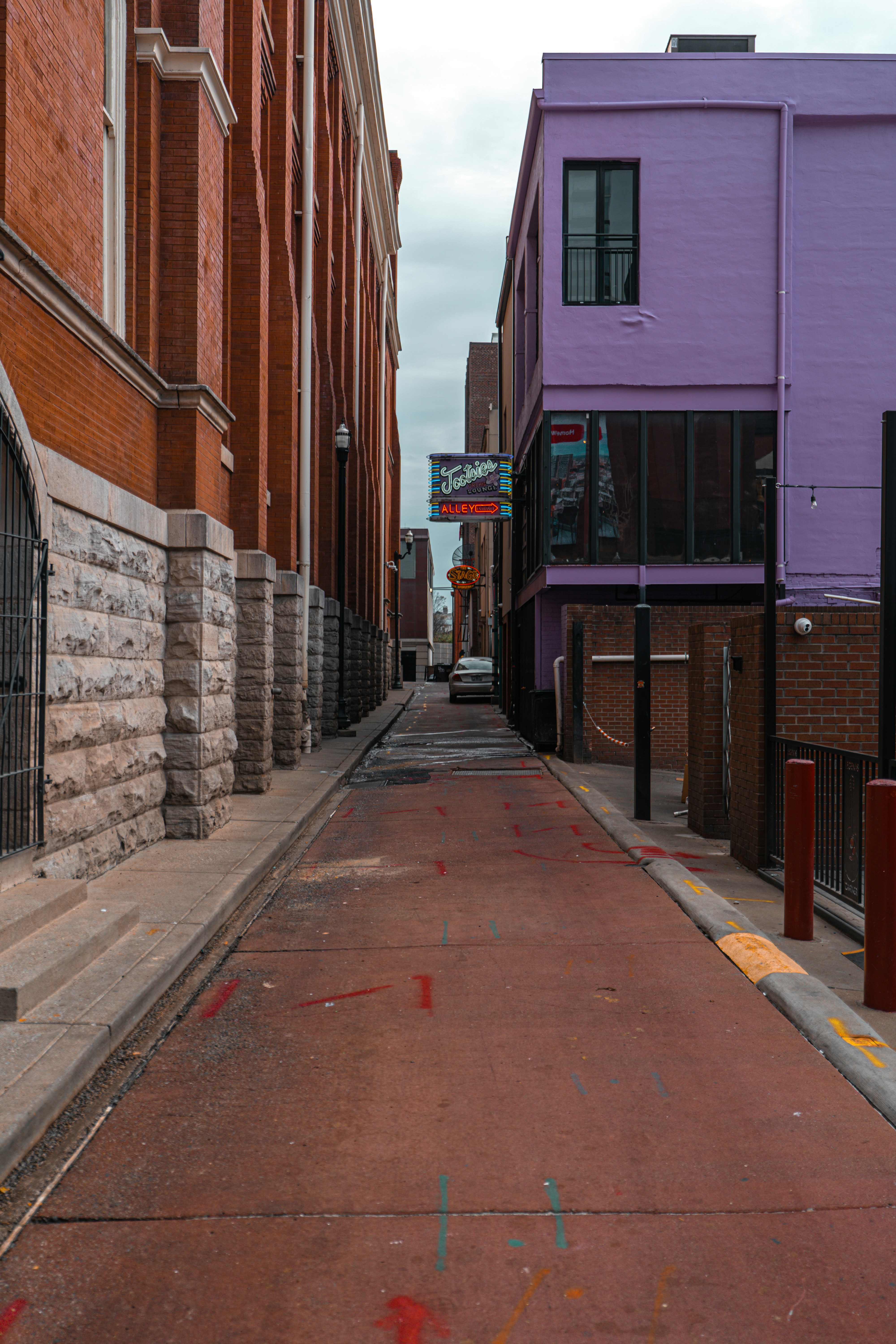 A narrow street is framed by buildings.