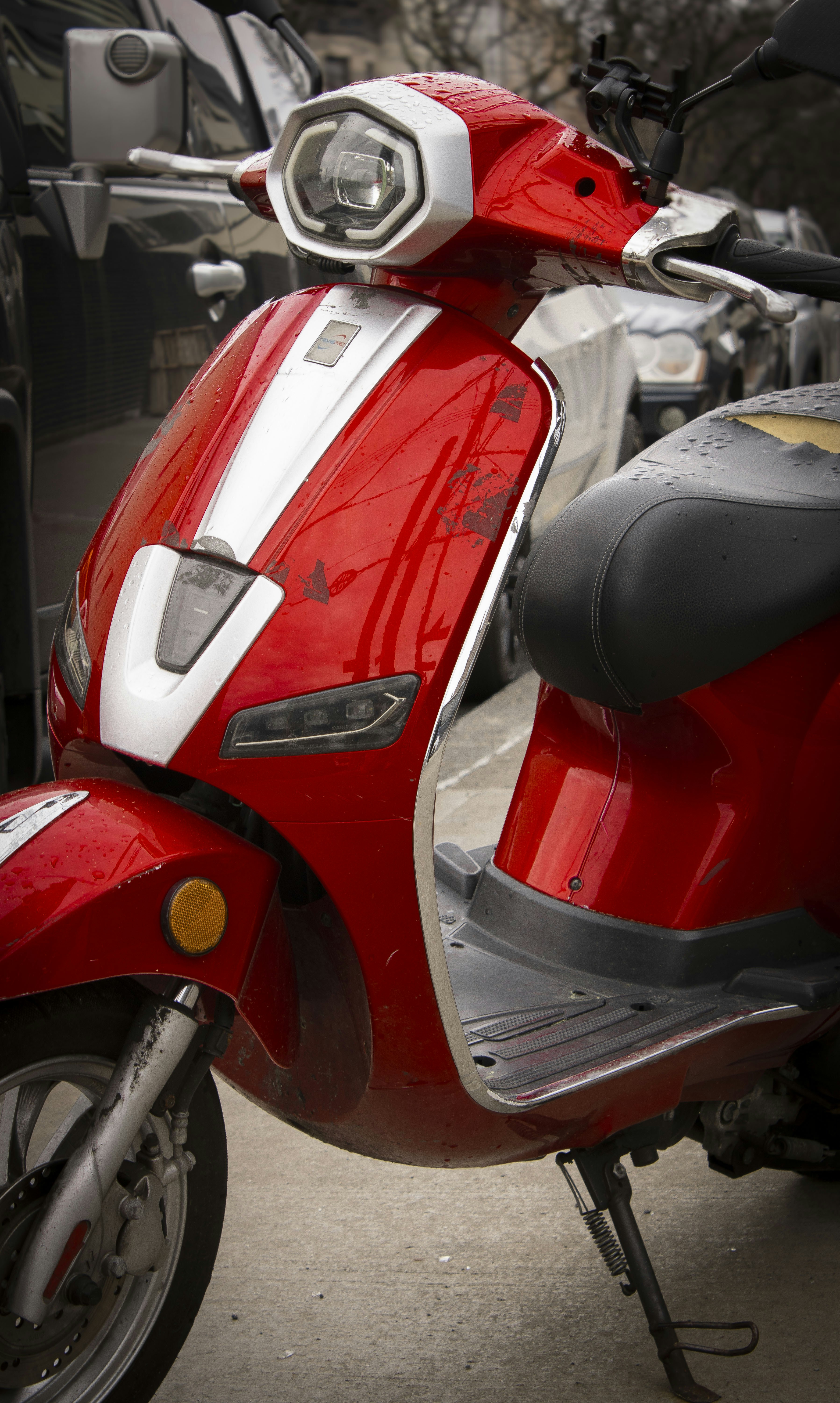 Crimson Comet in the City: A Red Scooter's Sculpted Silhouette