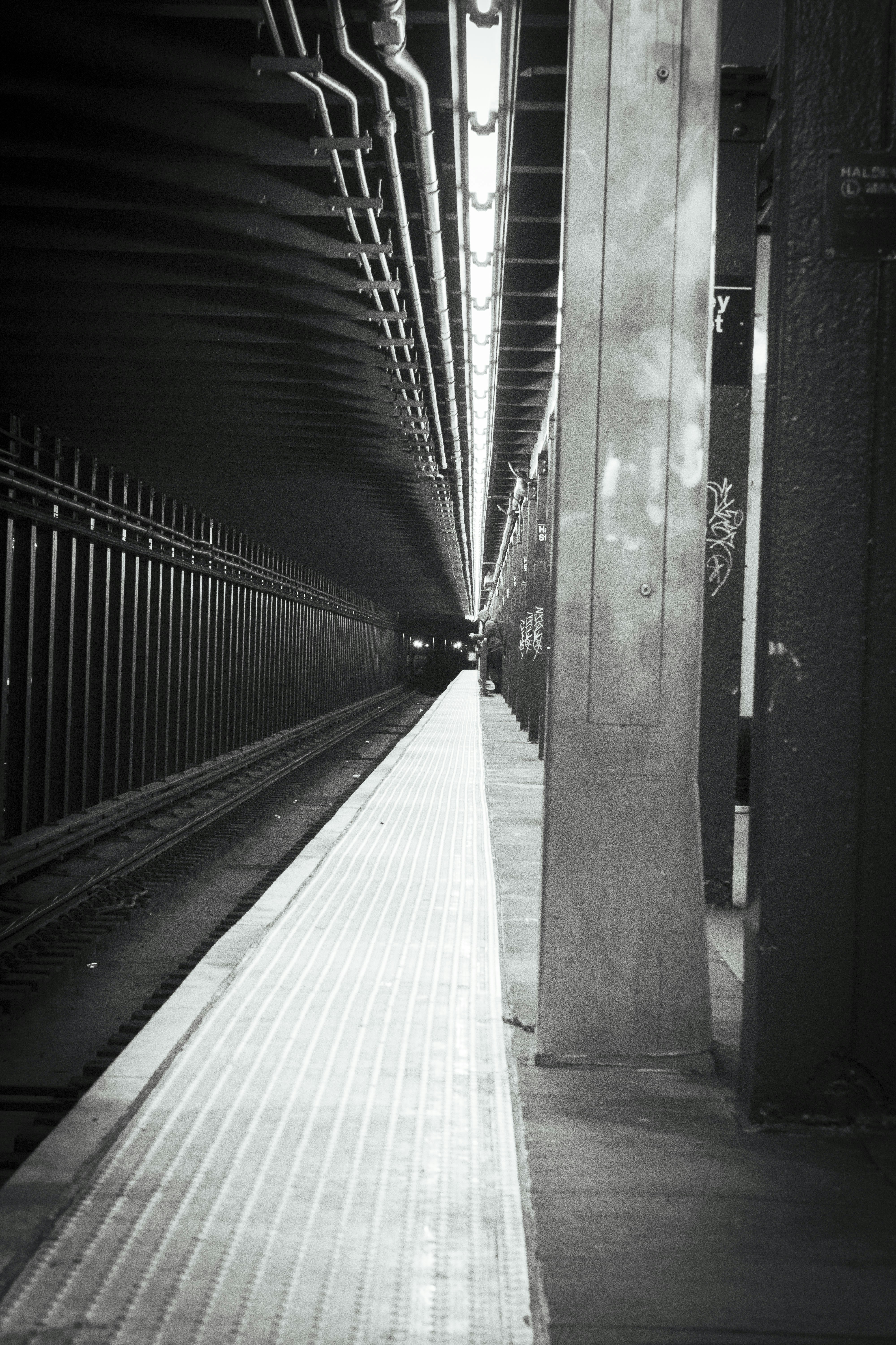 Monochrome Convergence: A Subway Platform Reaching Its Vanishing Point
