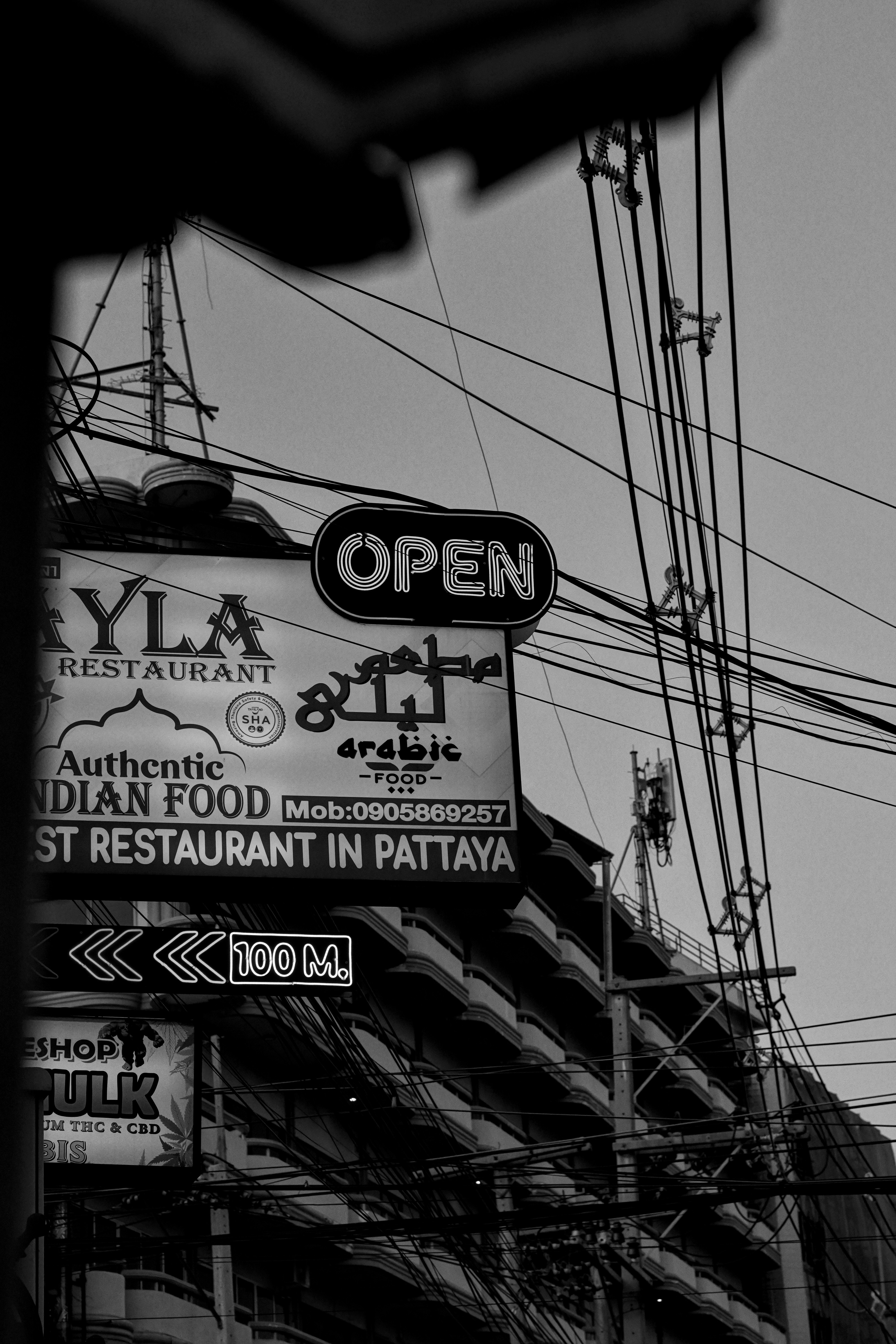 Open Neon in a Web of Wires Over Pattaya's Indian Restaurant
