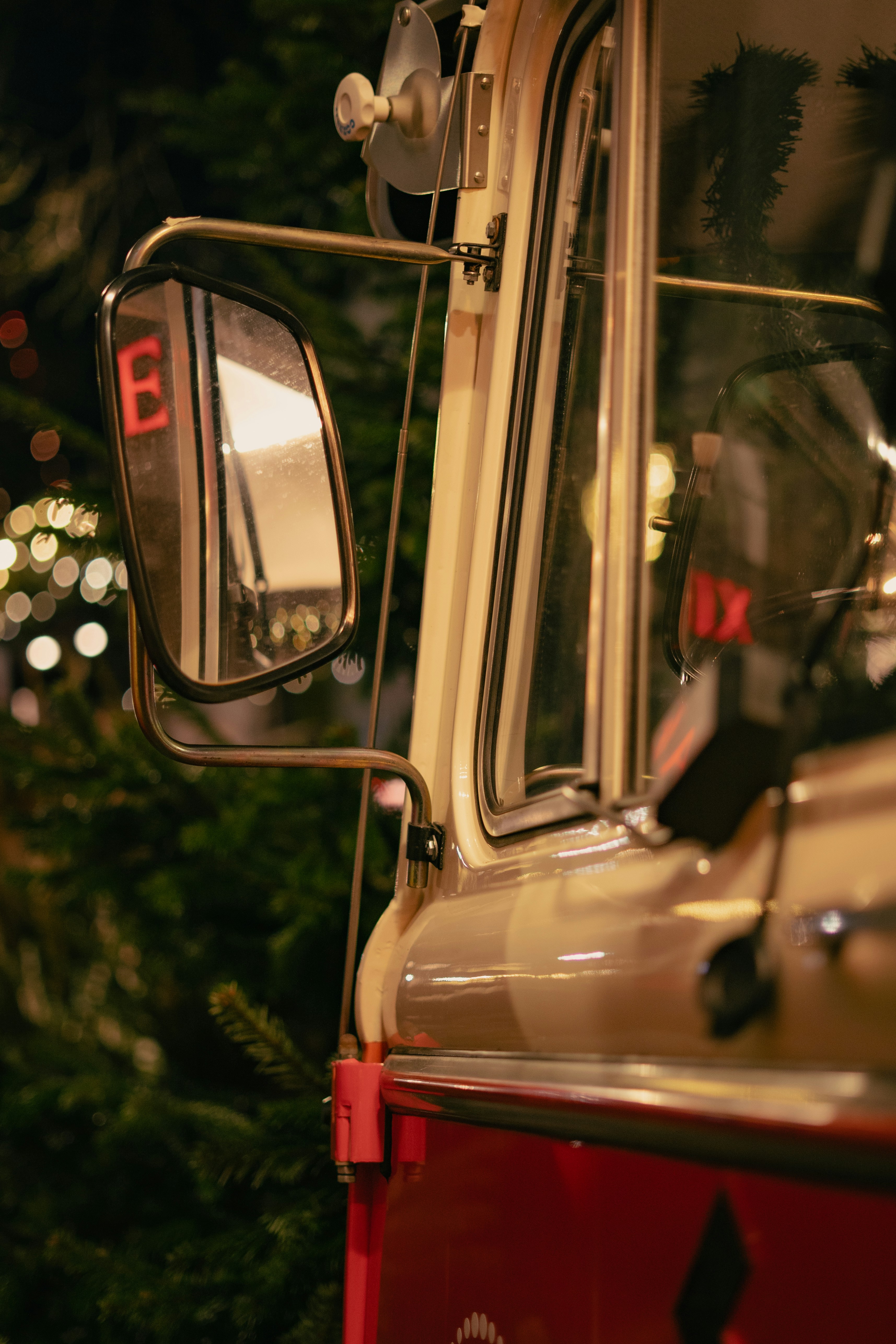 A vintage tram's side window and mirror.
