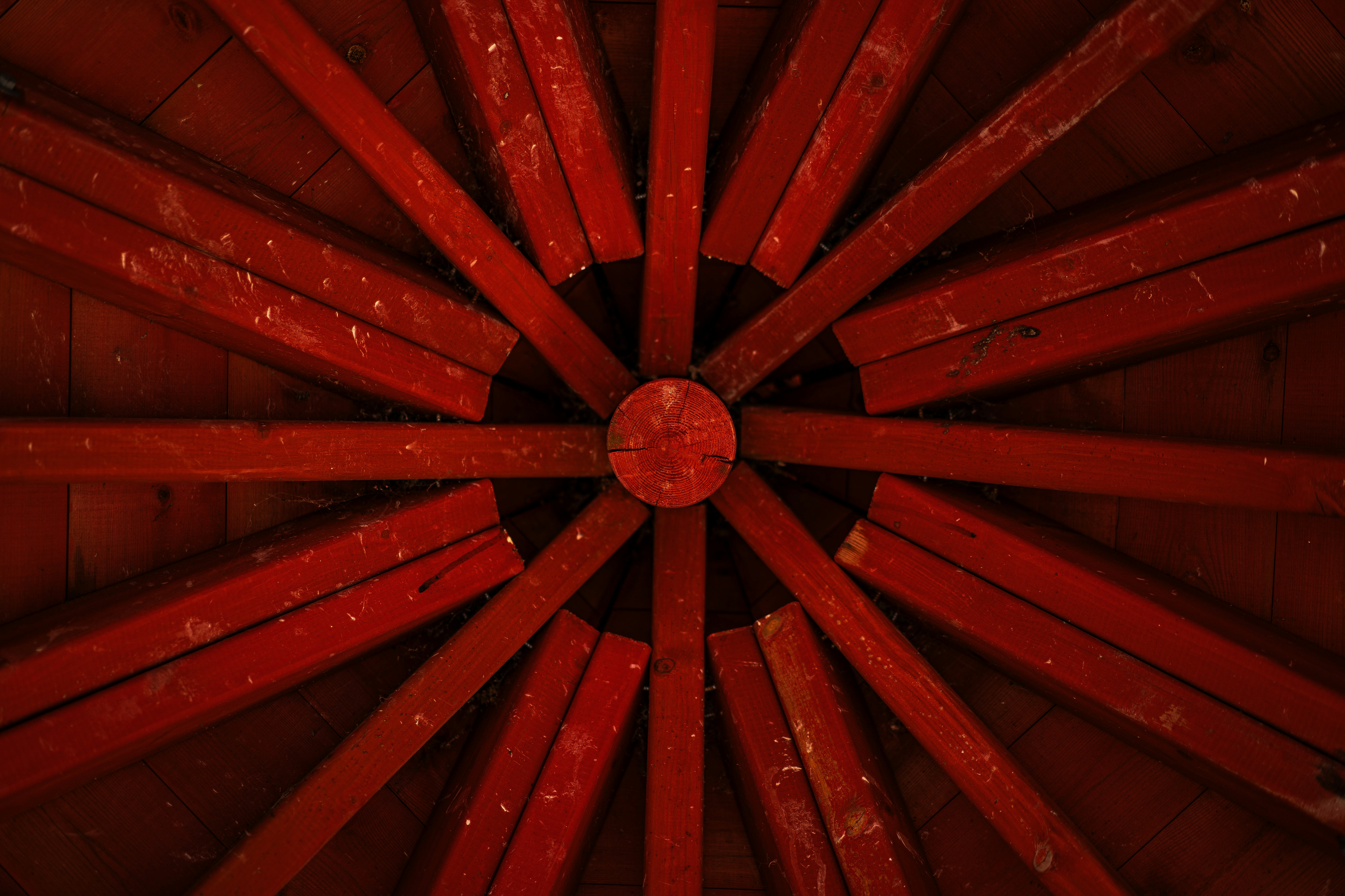 Red wooden beams radiate from a central point. photo – Free Abstract ...