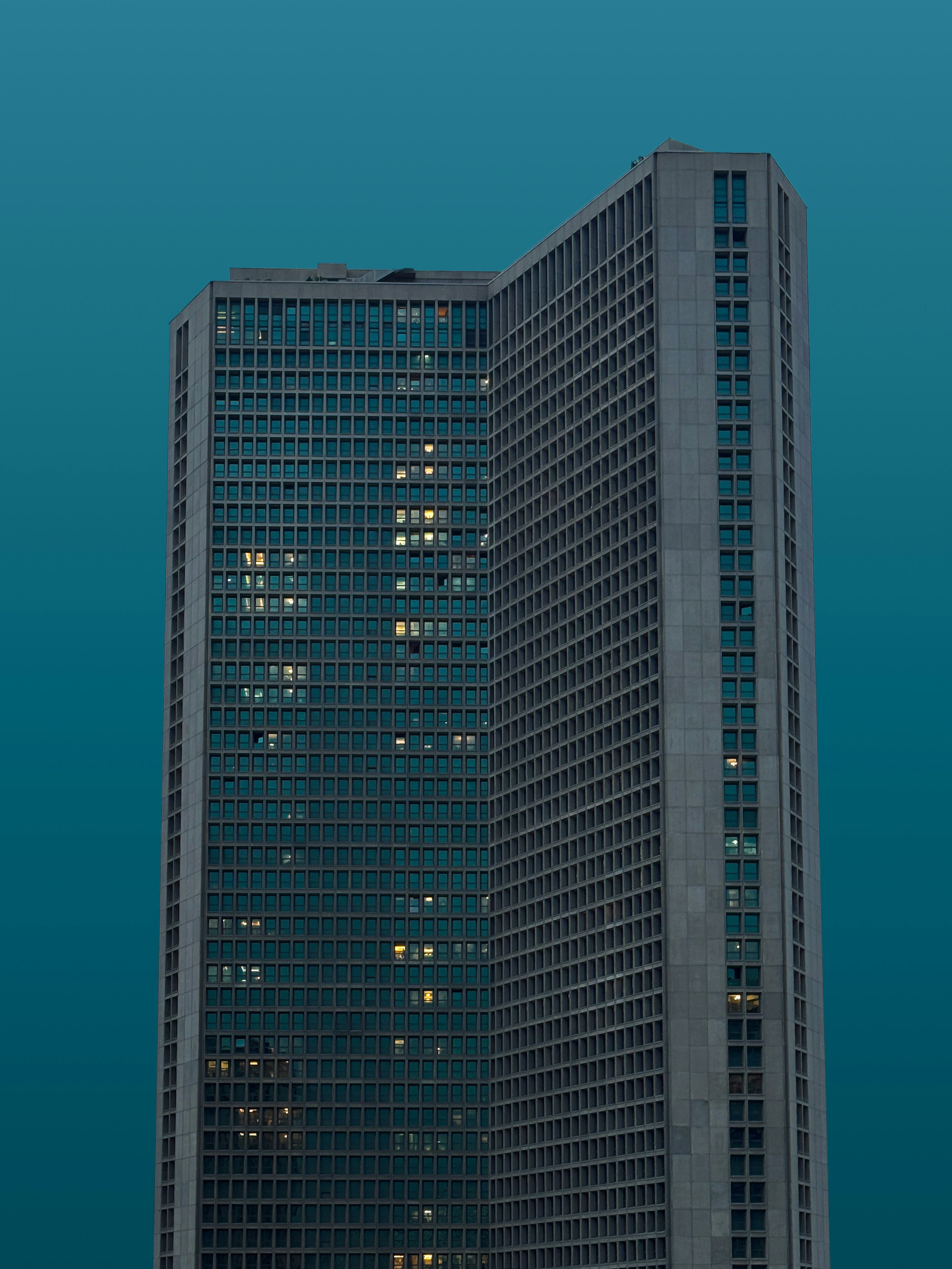 Twin-Window Skyscraper Against Gradient Teal Sky