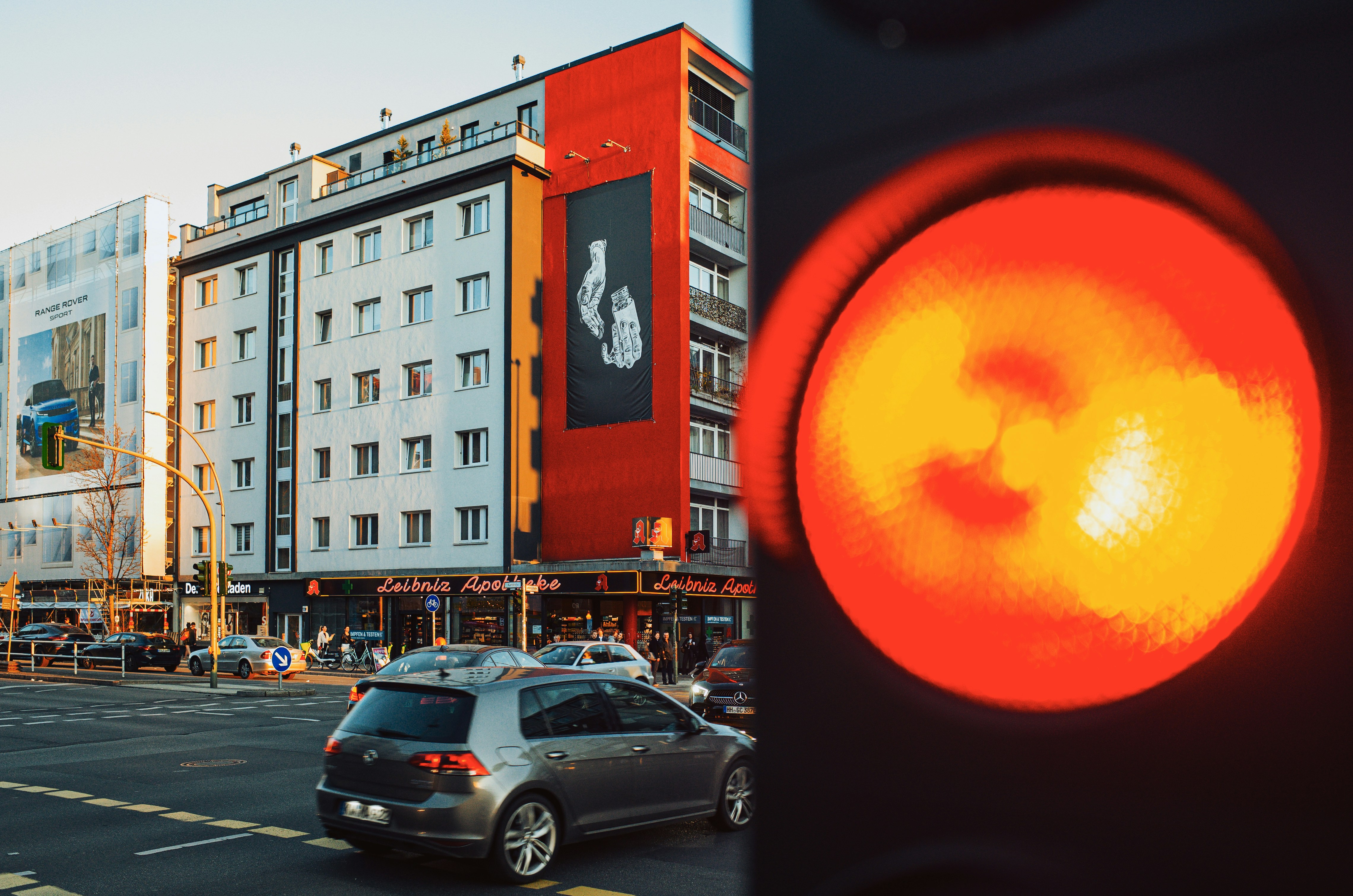 Converging Axes: A City Street Framed by a Red Signal
