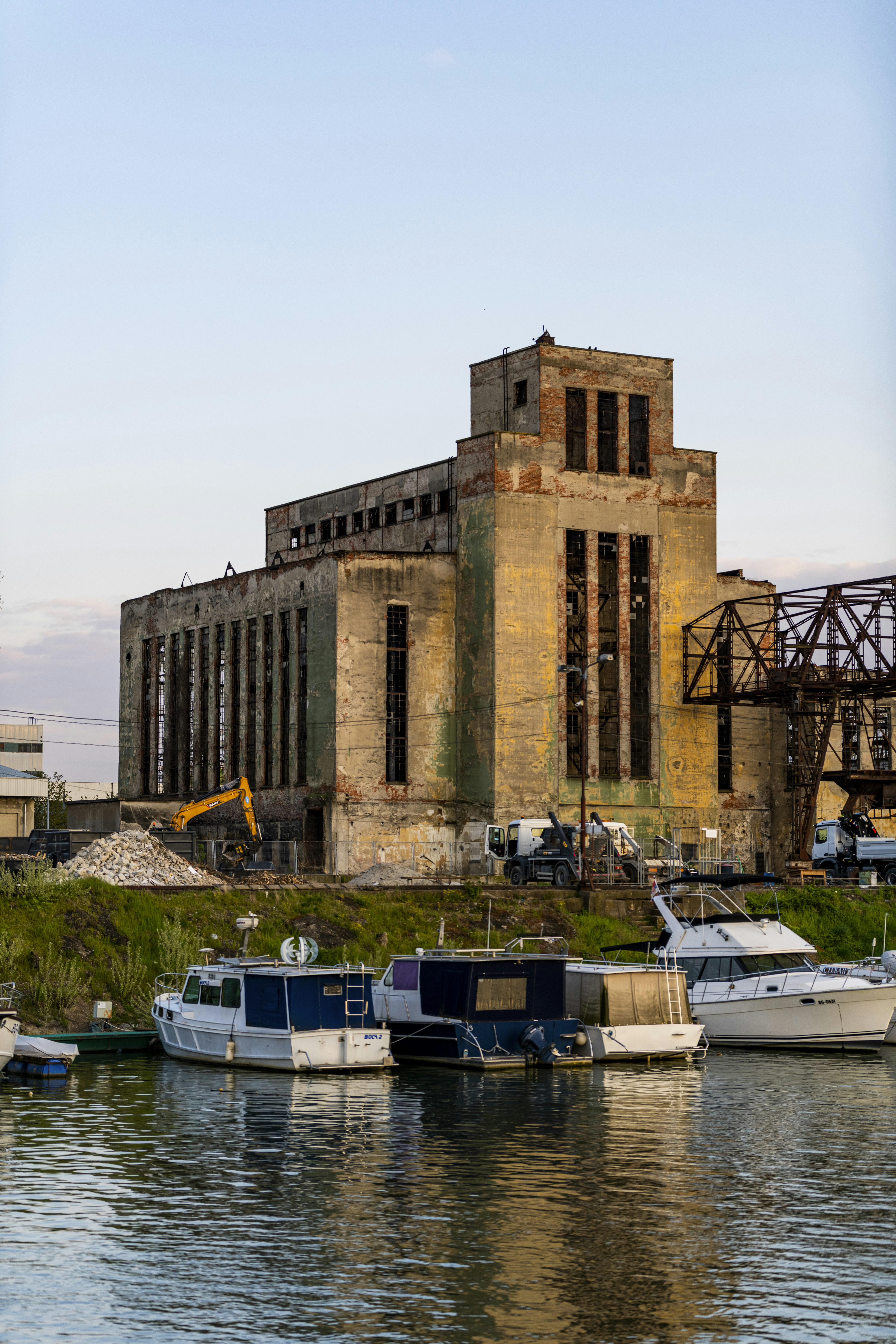 Brick Behemoth by the Docks: Weathered Factory Framing a Quiet Marina