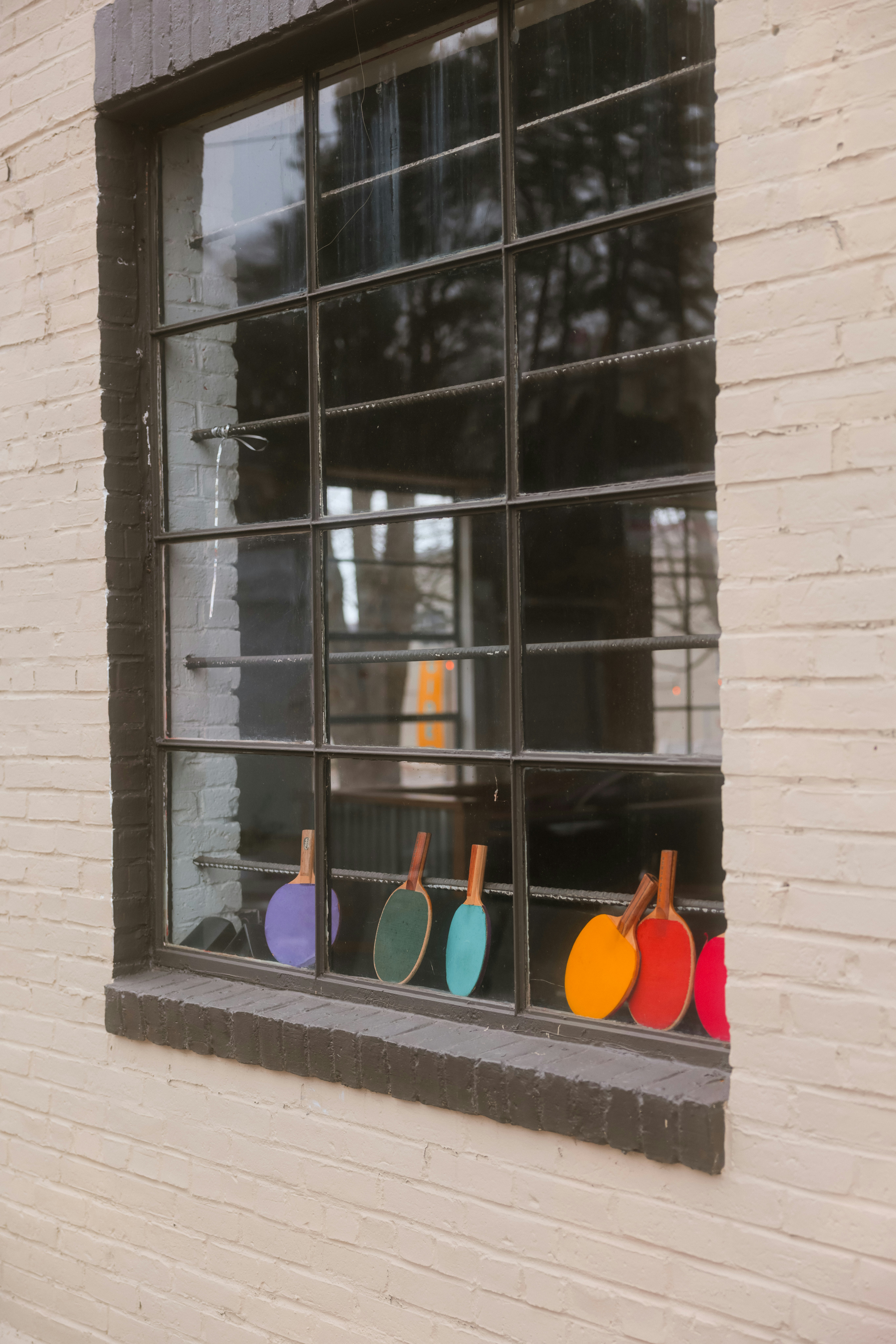 Colorful Discs Row: A Brick Window Still-Life