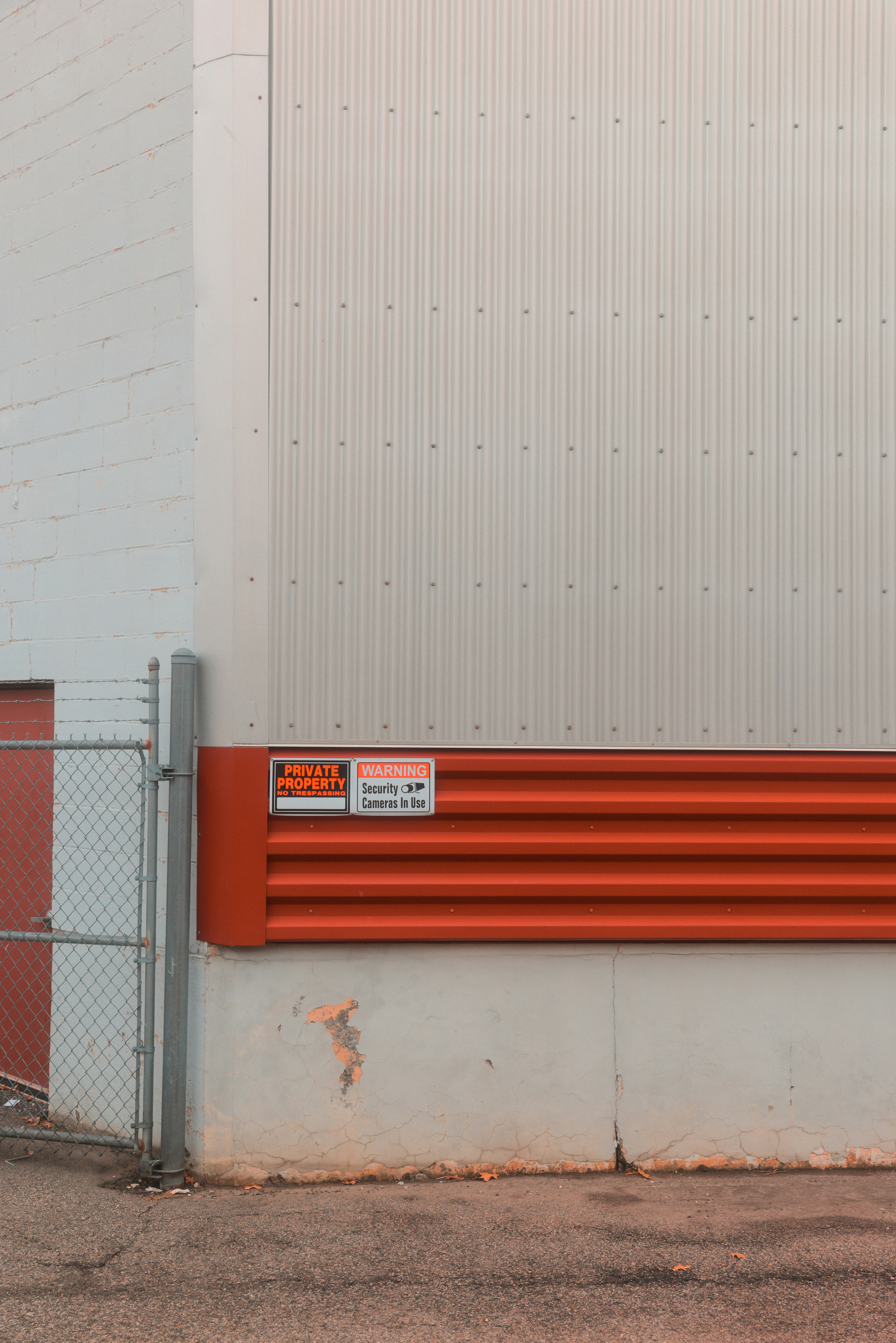 Guarded Wall, Orange Vent, and Chain-Link: A Quiet Industrial Moment