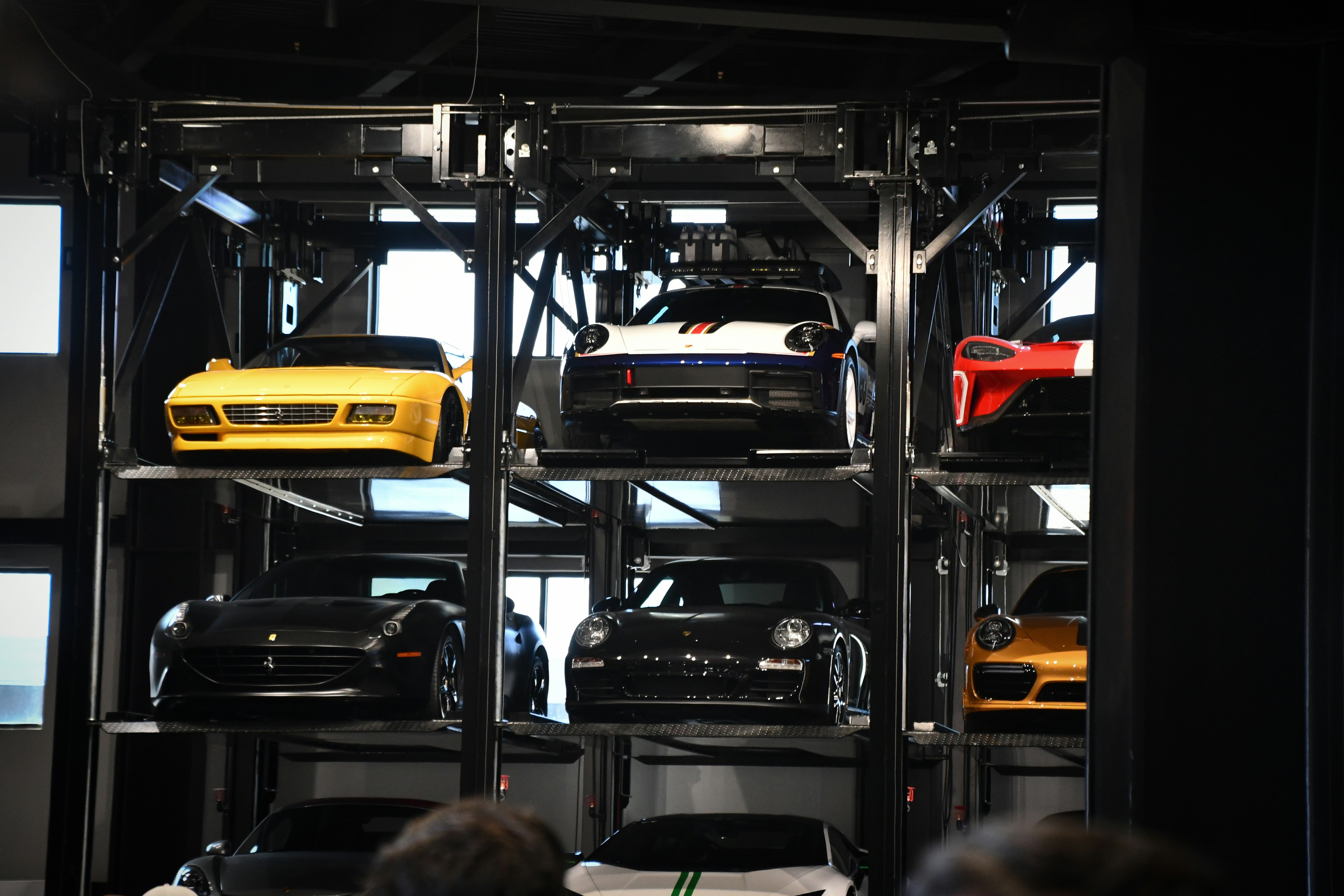 Cars are parked in a multi-level car lift. photo – Free Car Image on ...