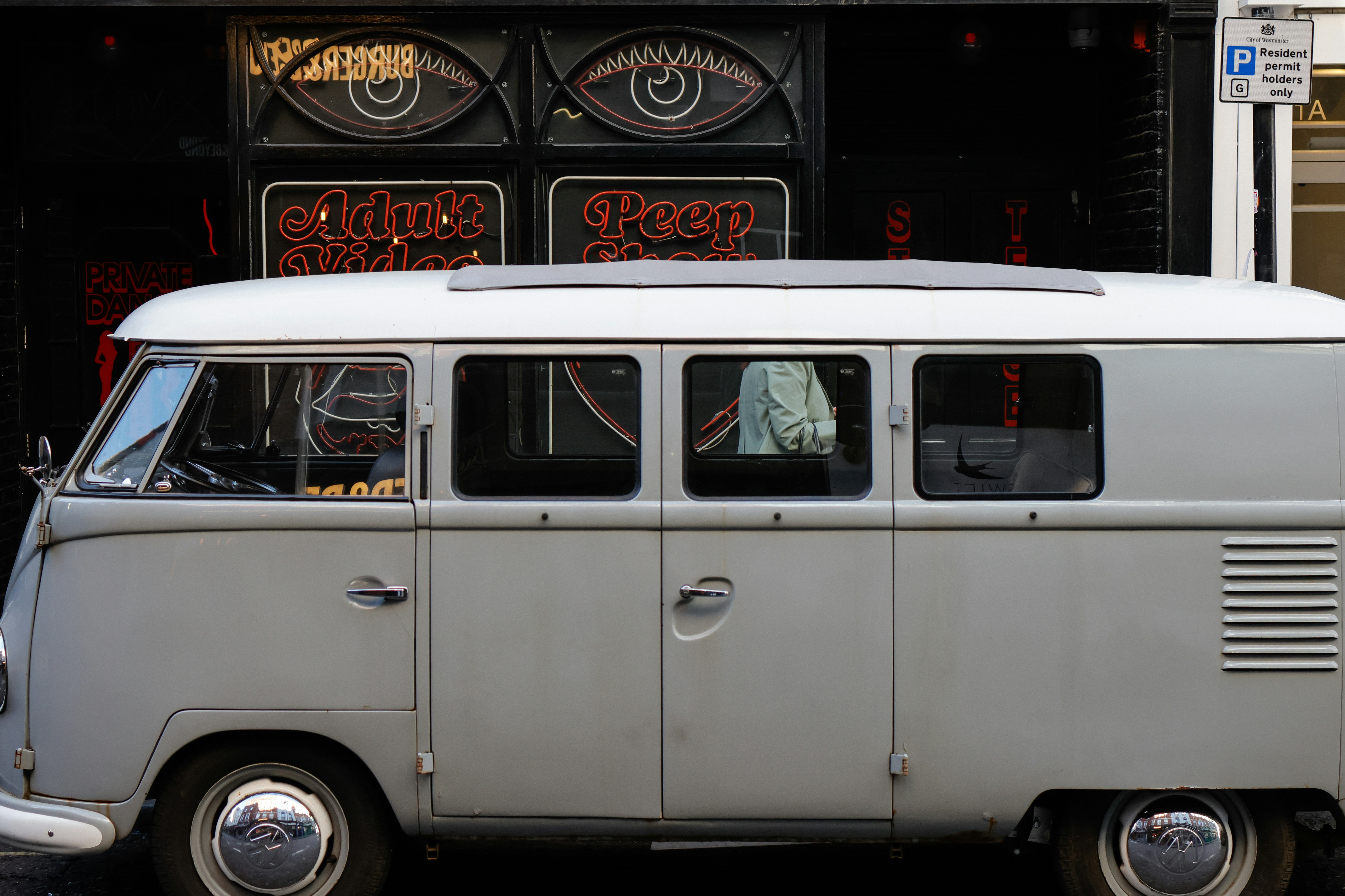 A vintage van is parked near a storefront. photo – Free Car Image on ...