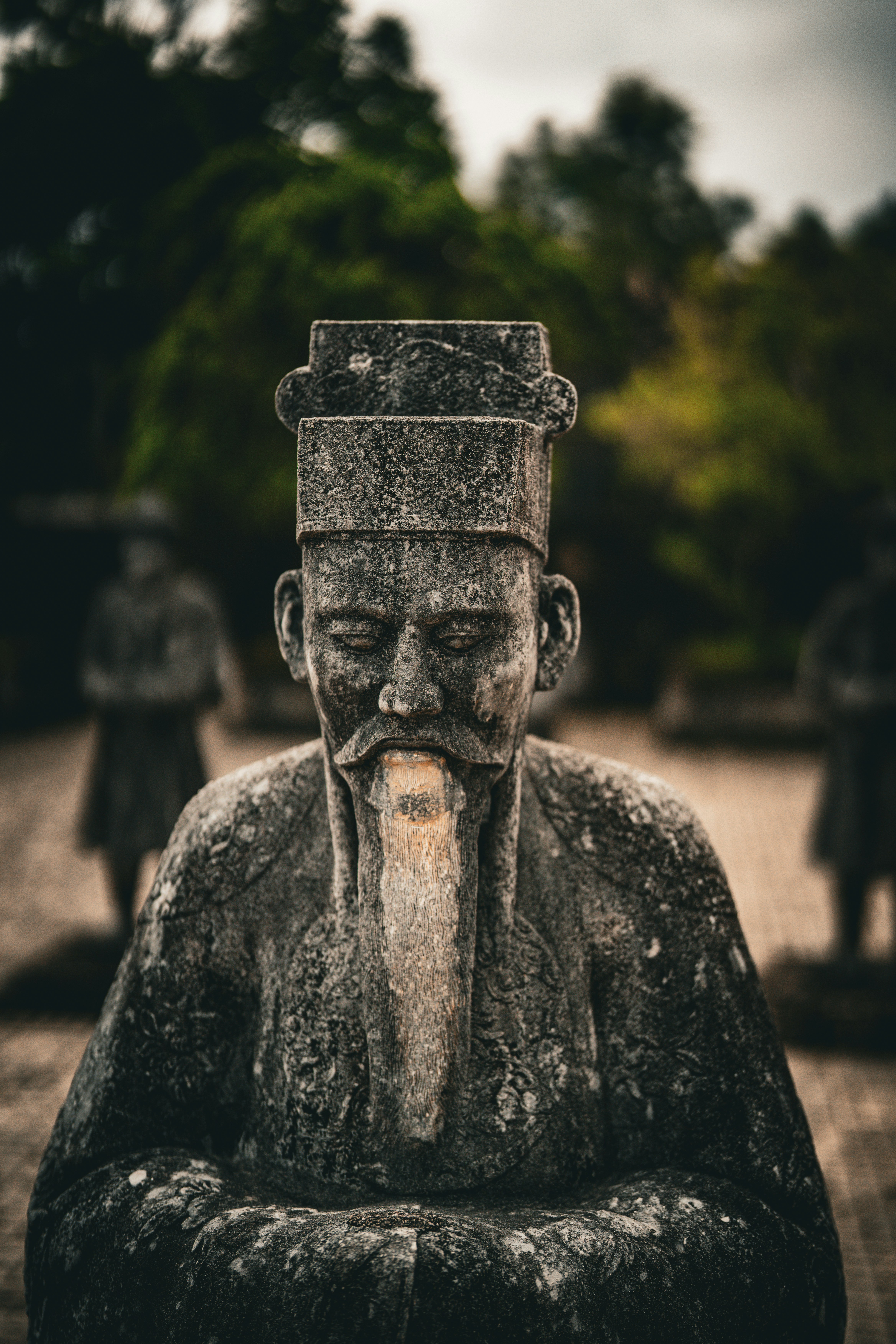 Weathered Guardian of the Garden: A Stone Sage in a Quiet Courtyard