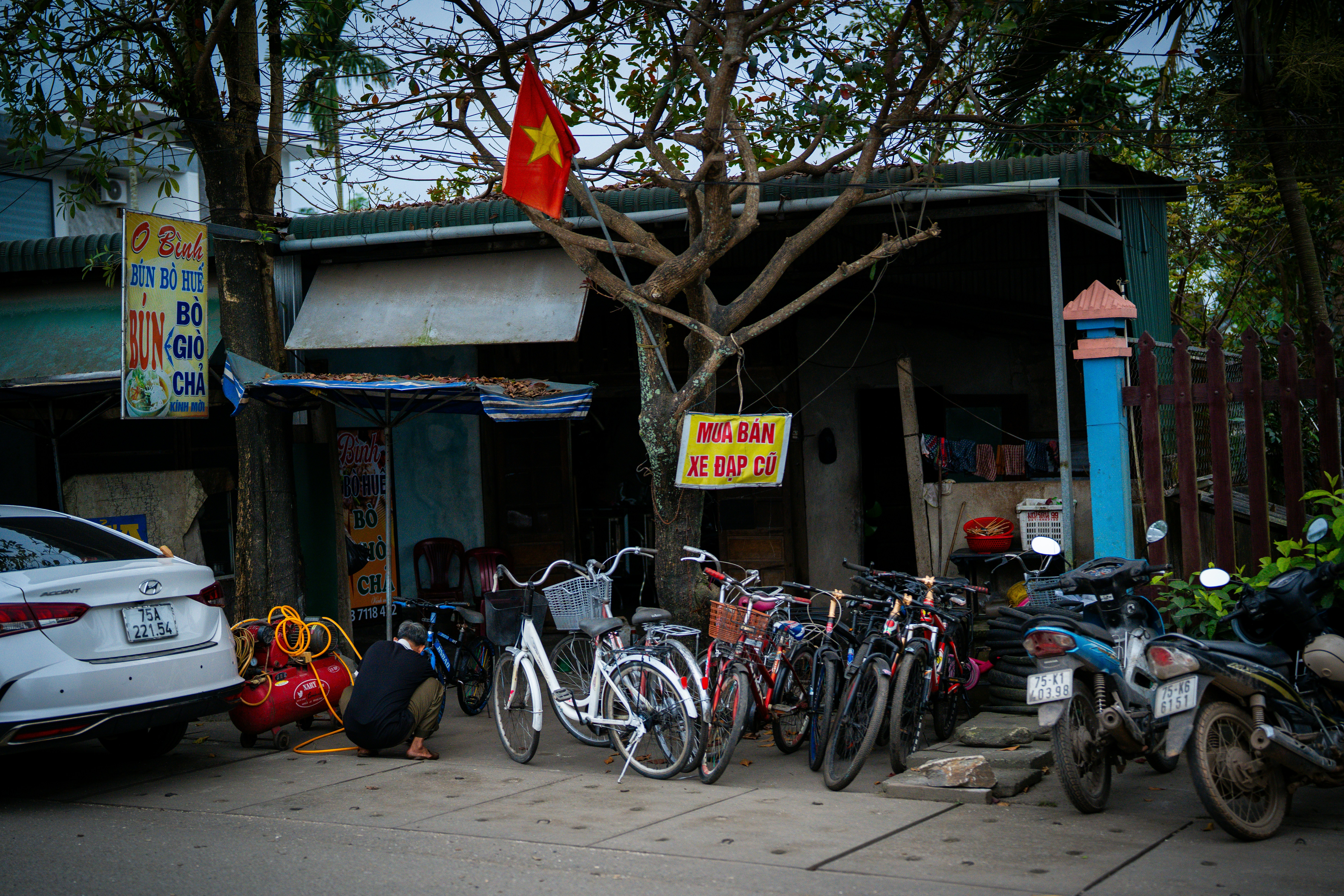 Bikes Under a Vietnamese Flag: A Quiet Street Corner