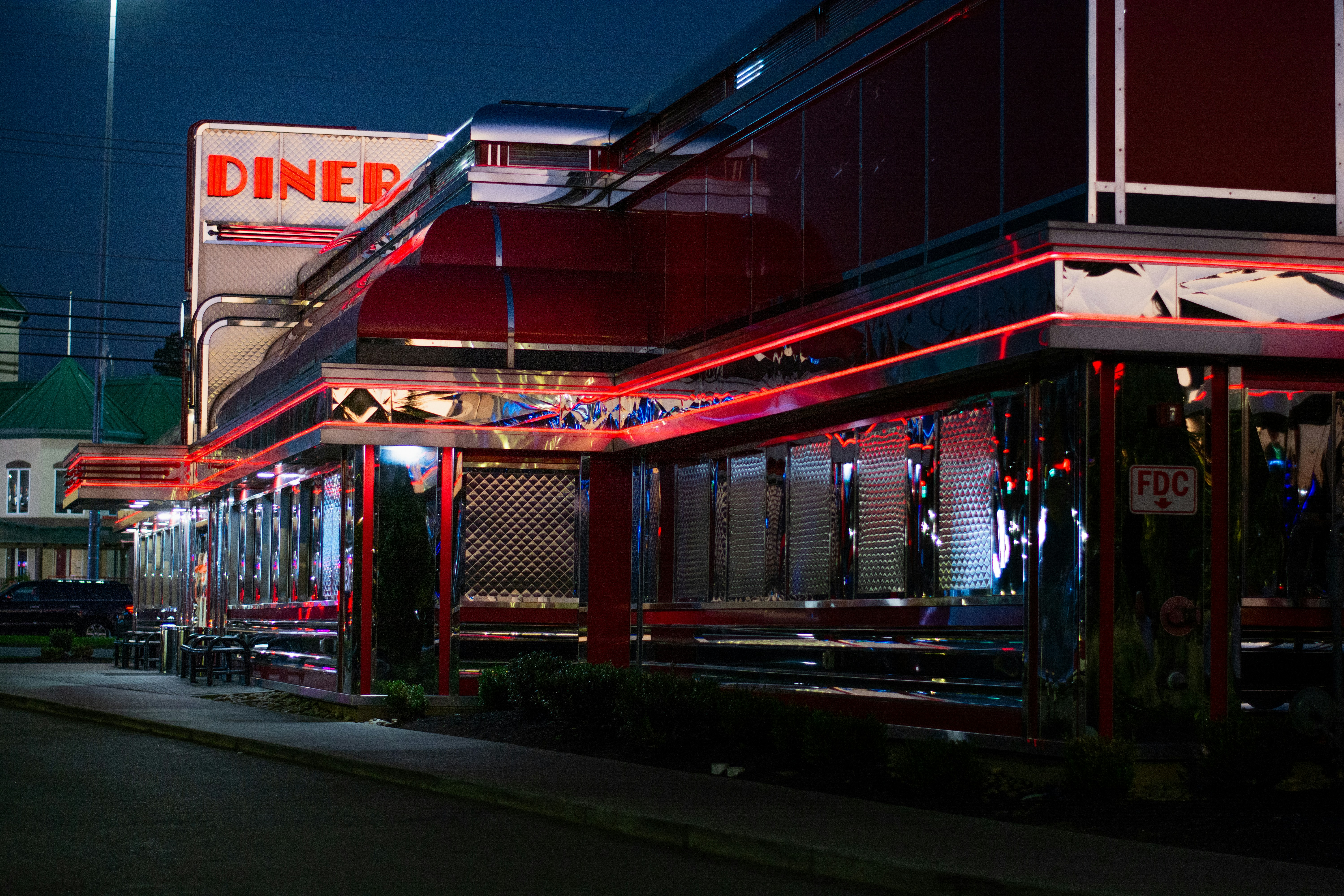 A diner is seen at night with neon lights.