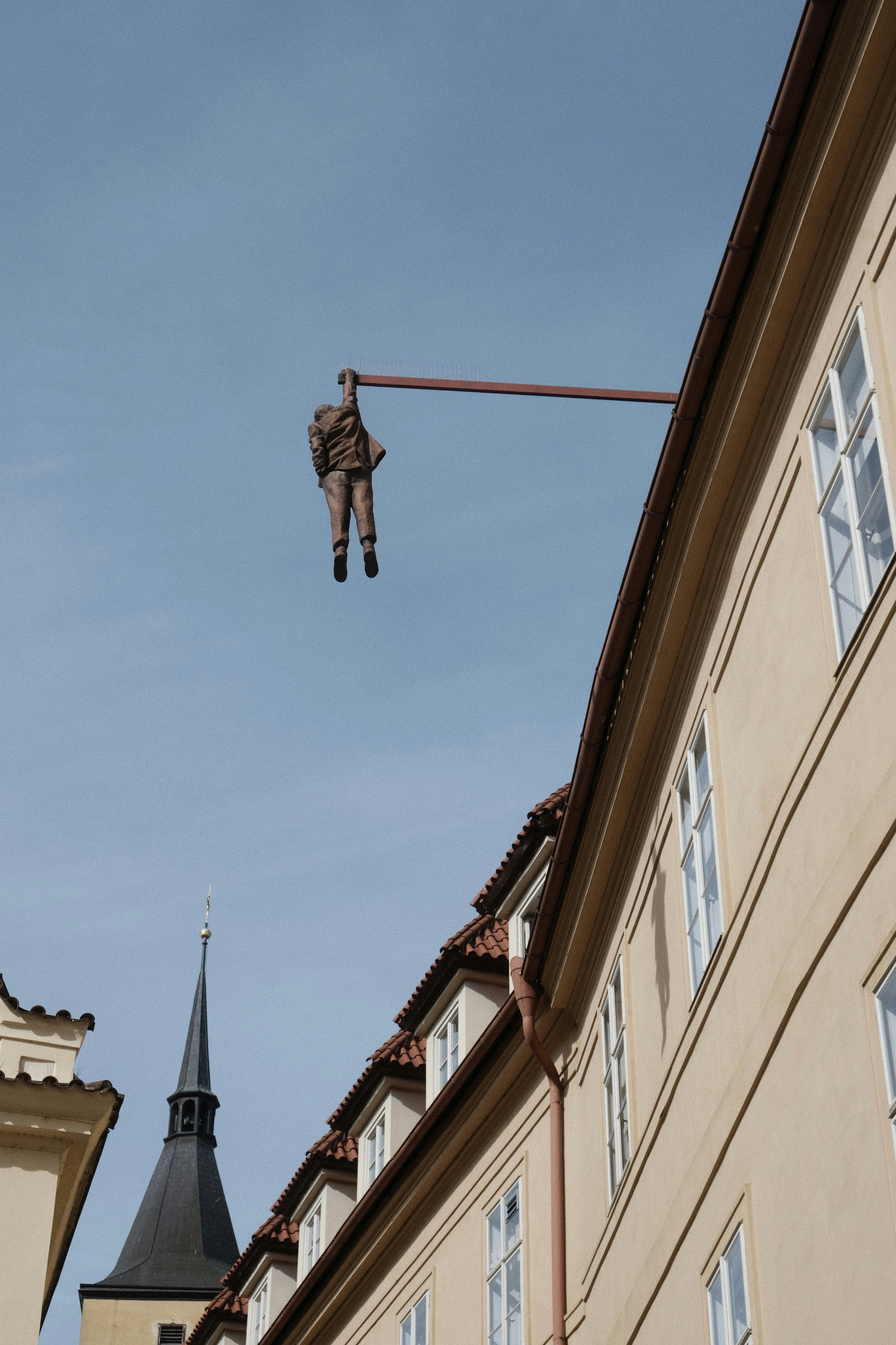 Suspended Figure in Urban Sky