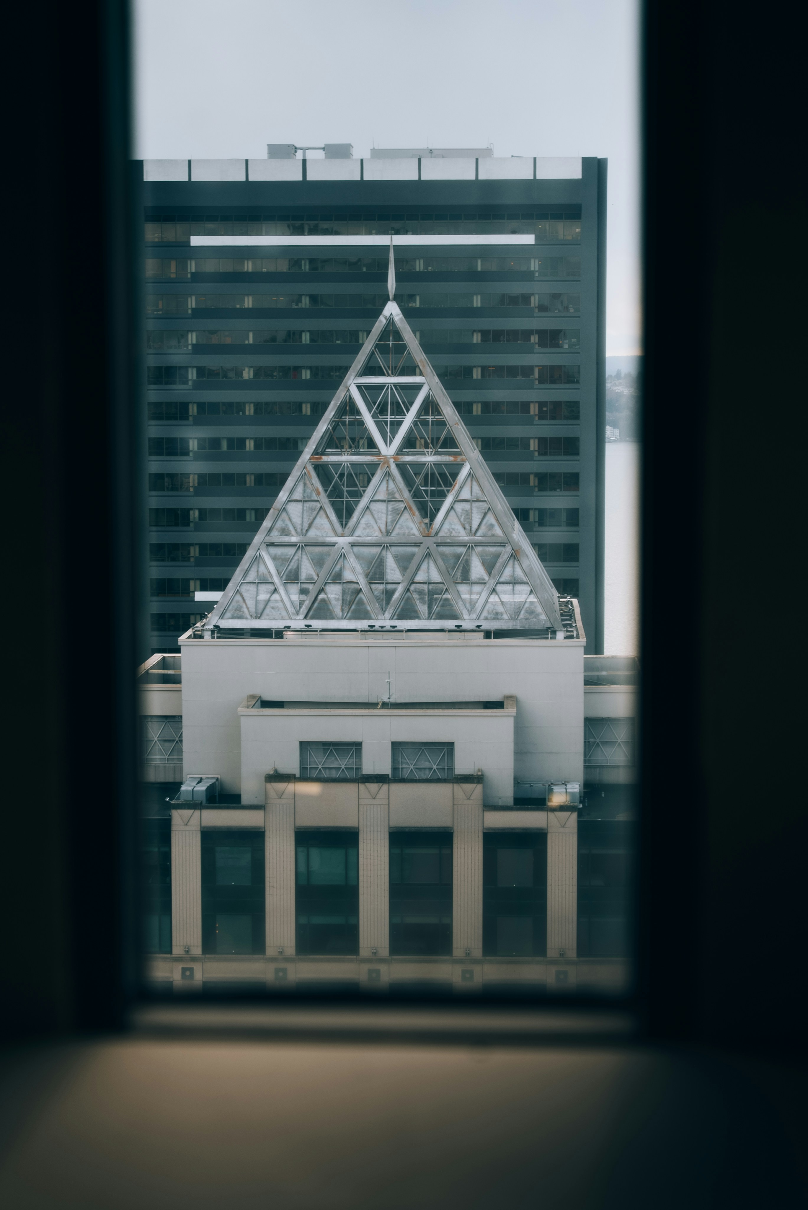 A pyramid-shaped structure atop a city building. photo – Free Building ...