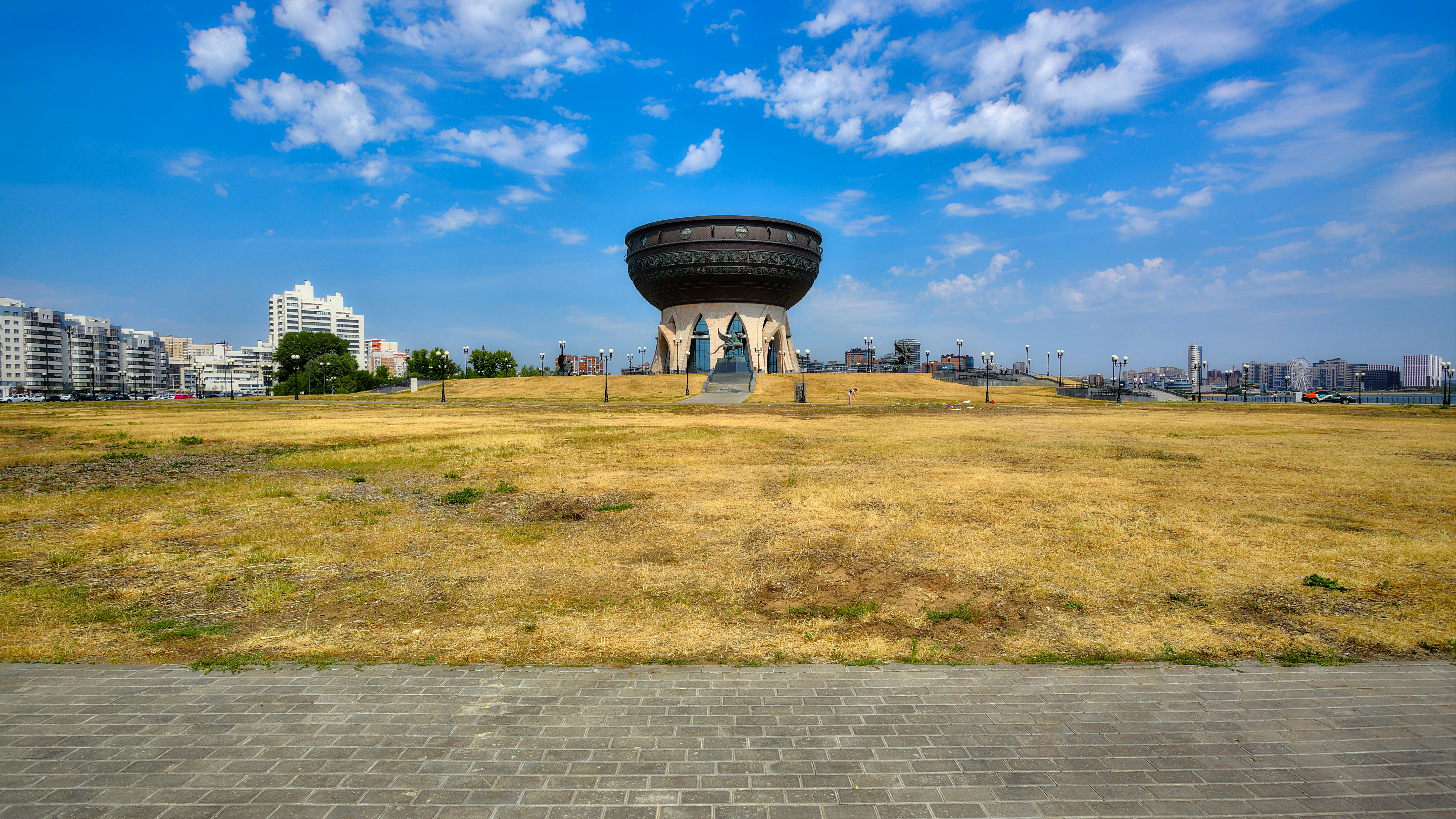 A unique building stands on a large open plain. photo – Free City Image ...