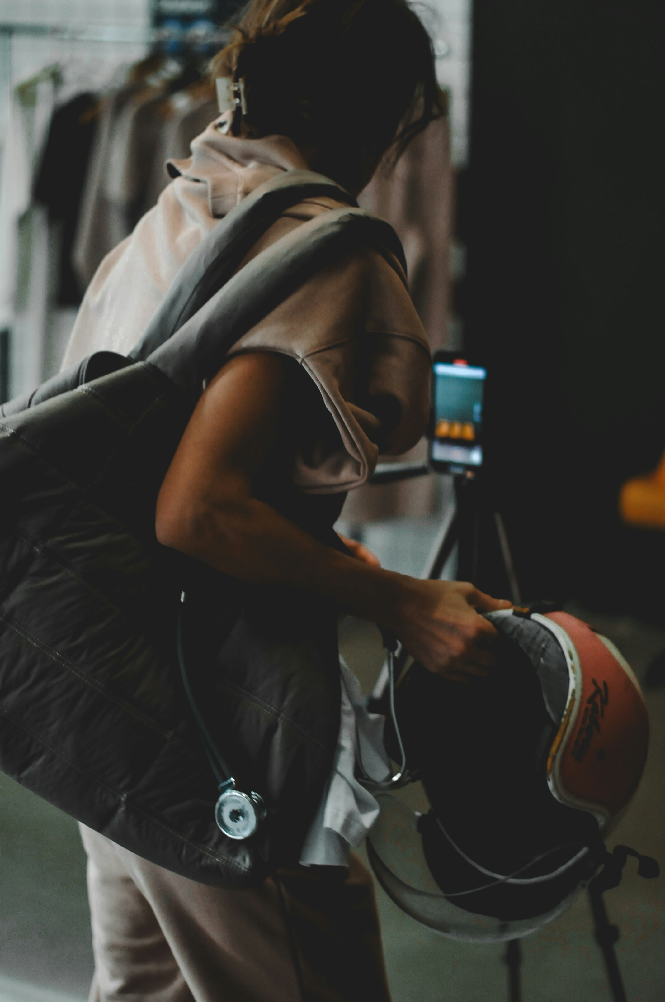 Pre-Flight Prep: A Rider Secures Gear in a Dim Studio