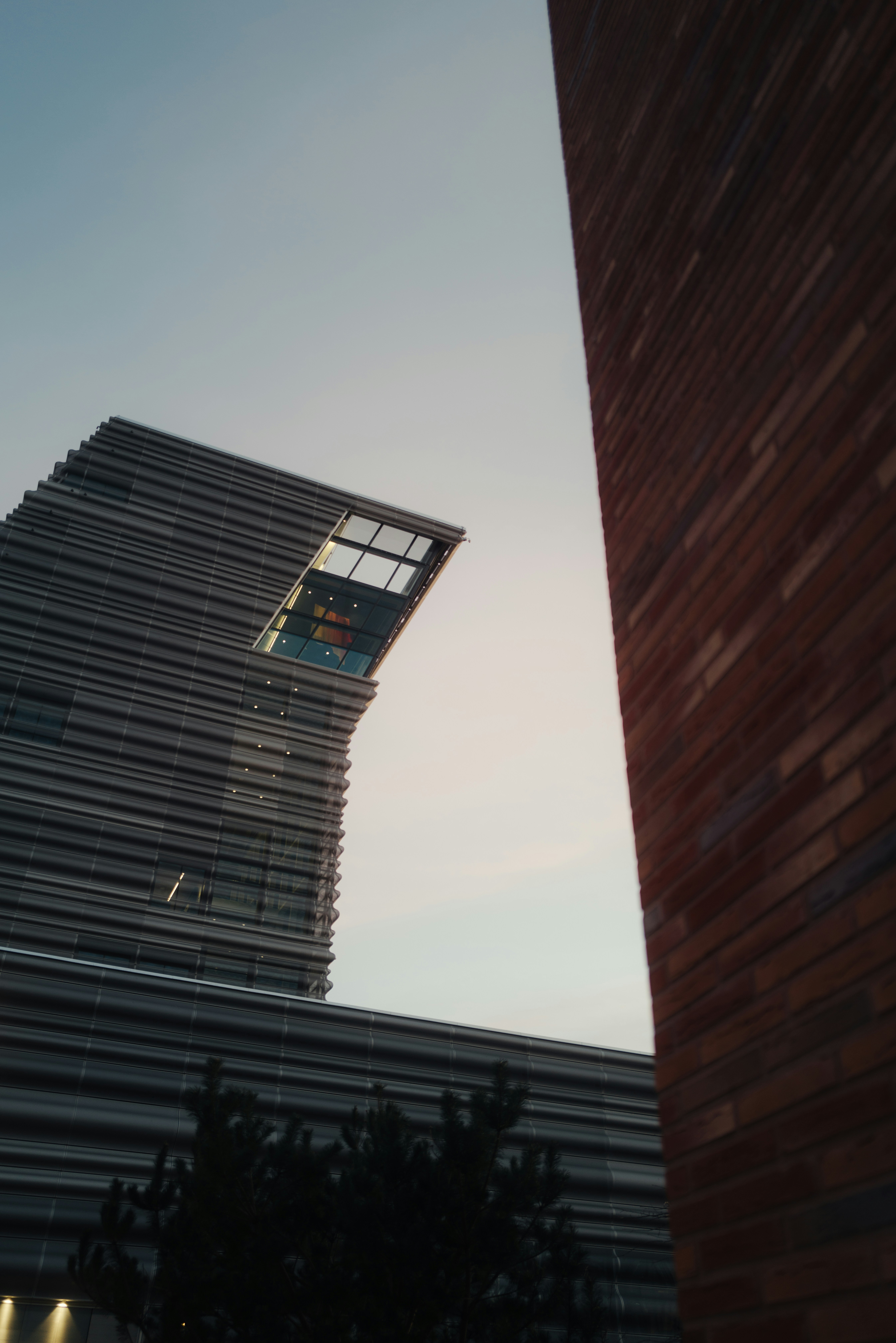 Modern architectural structures with angled lines against a twilight sky.