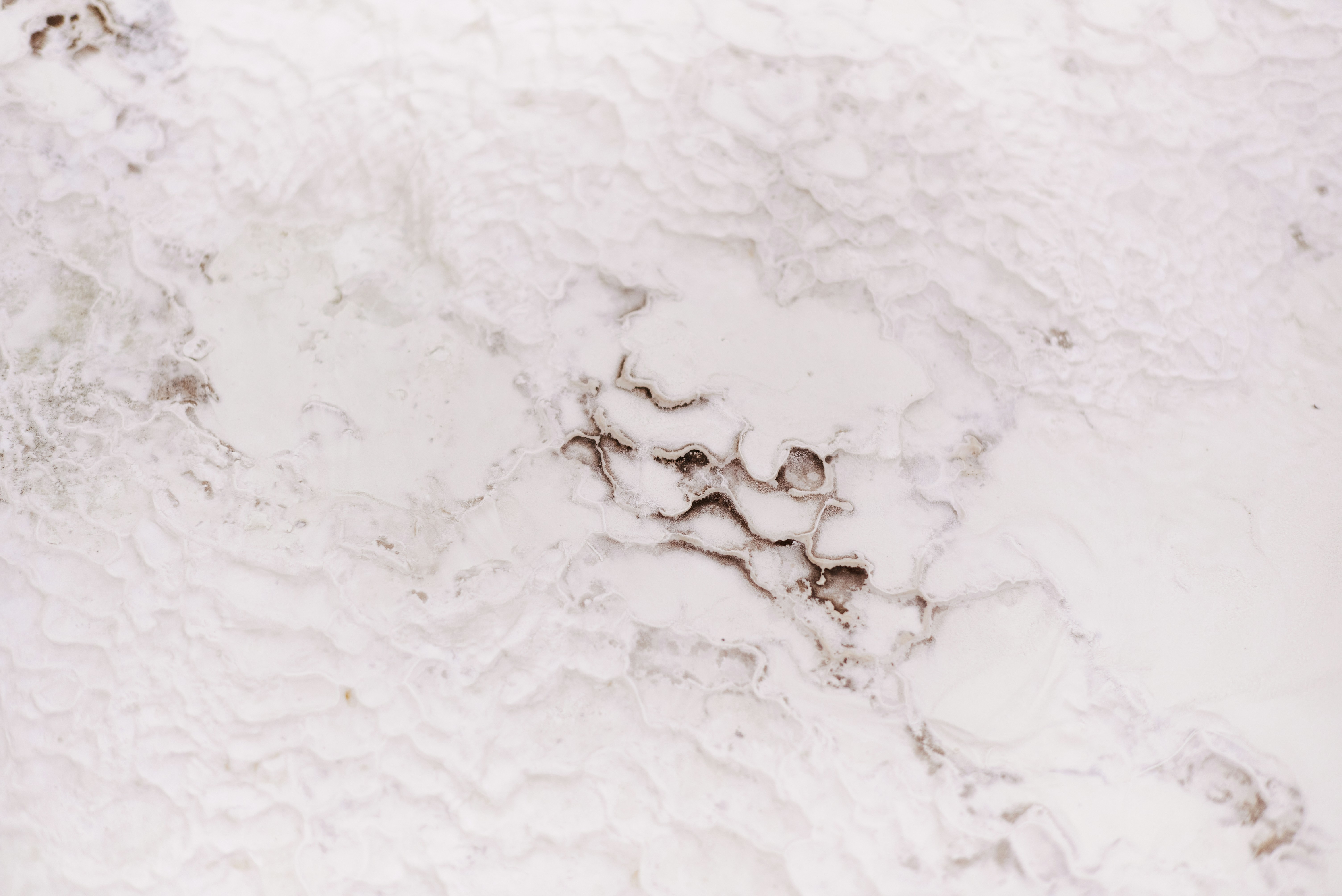 Aerial view of Pamukkale's white mineral terraces with intricate natural patterns.