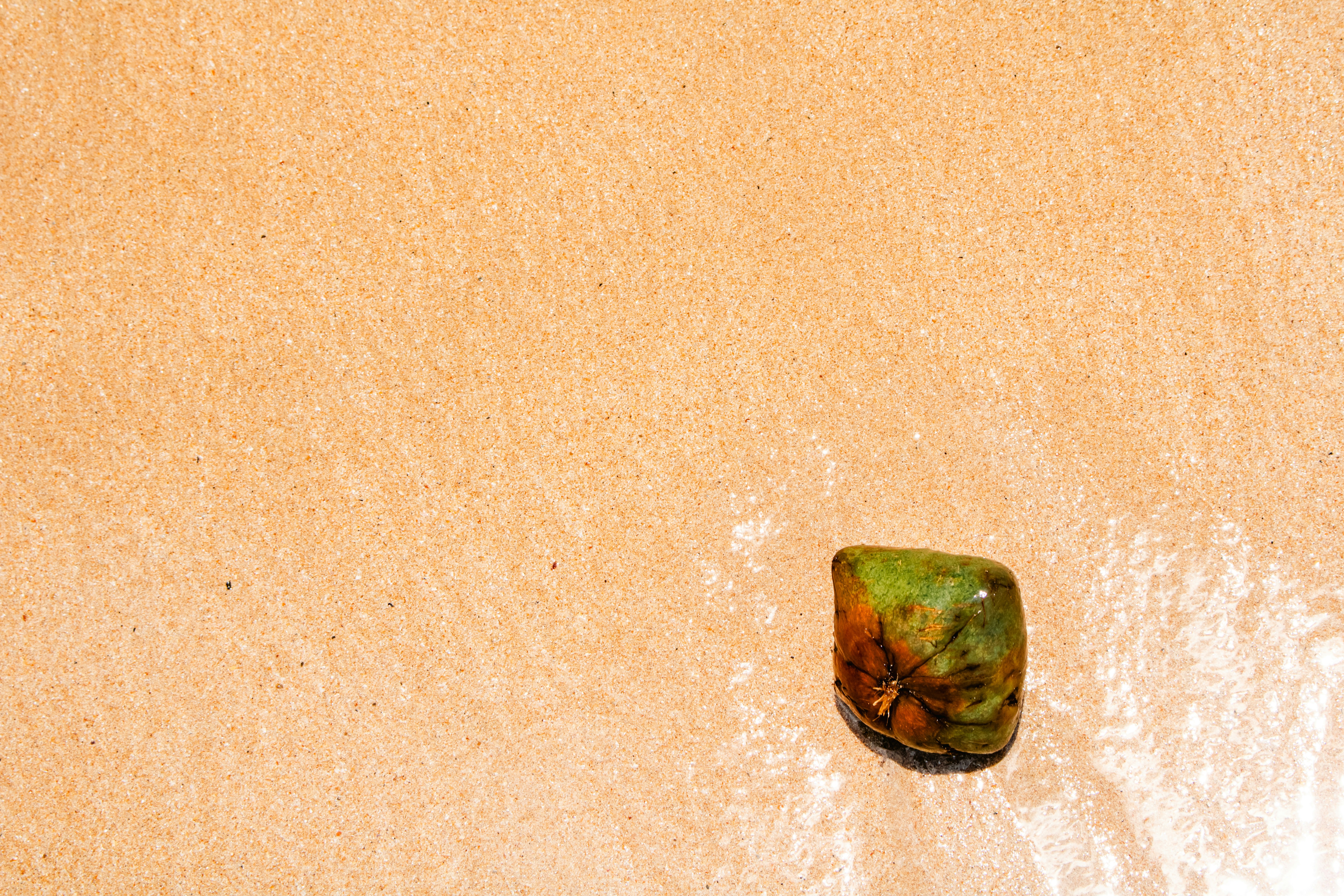 Emerald Cube on a Quiet Sand Shore