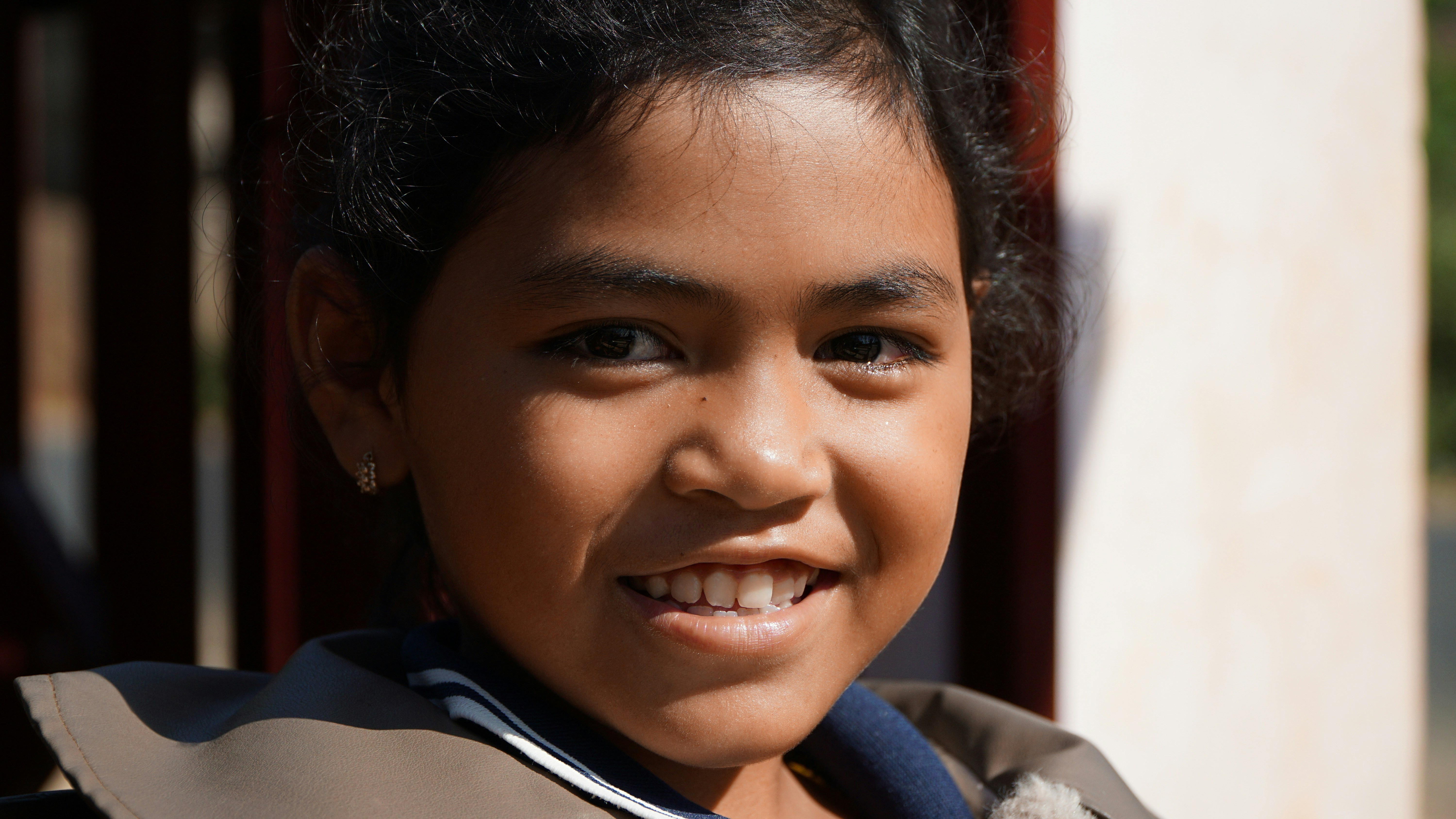 A happy girl smiles directly at the camera. photo – Free Girl Image on ...