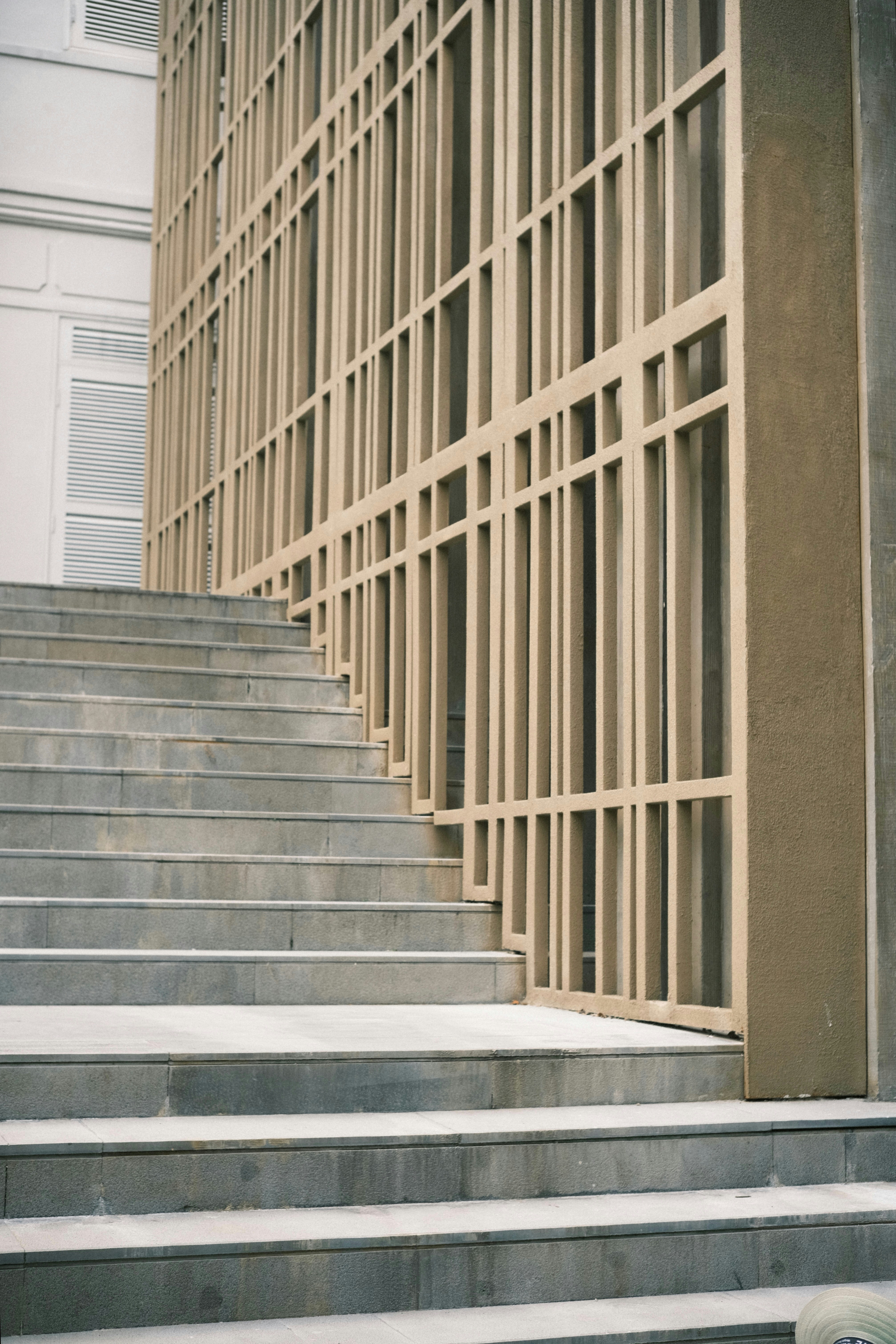 A staircase leads toward a grid-patterned wall. photo – Free Building ...