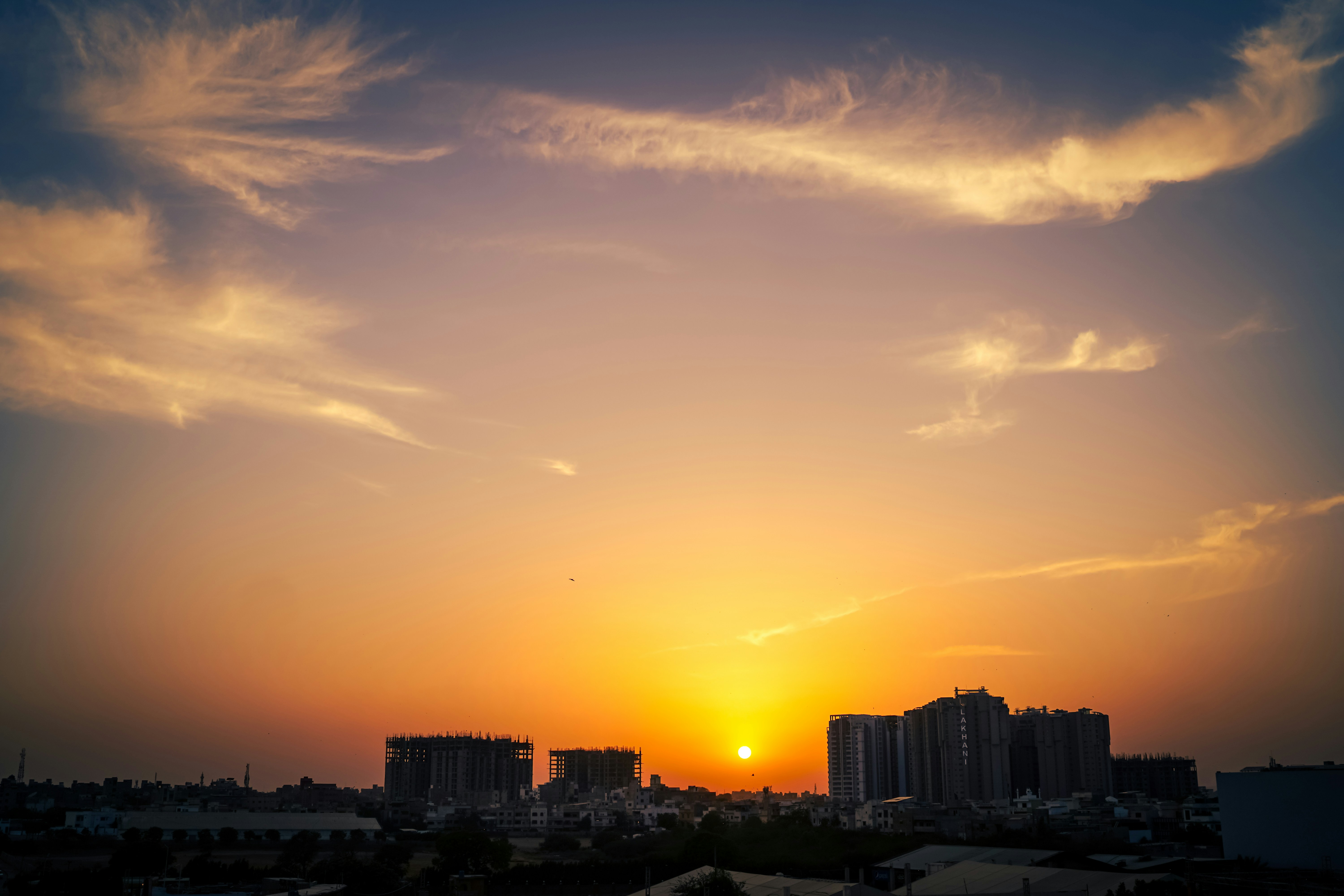 Sunset over a city skyline paints the sky. photo – Free City Image on ...