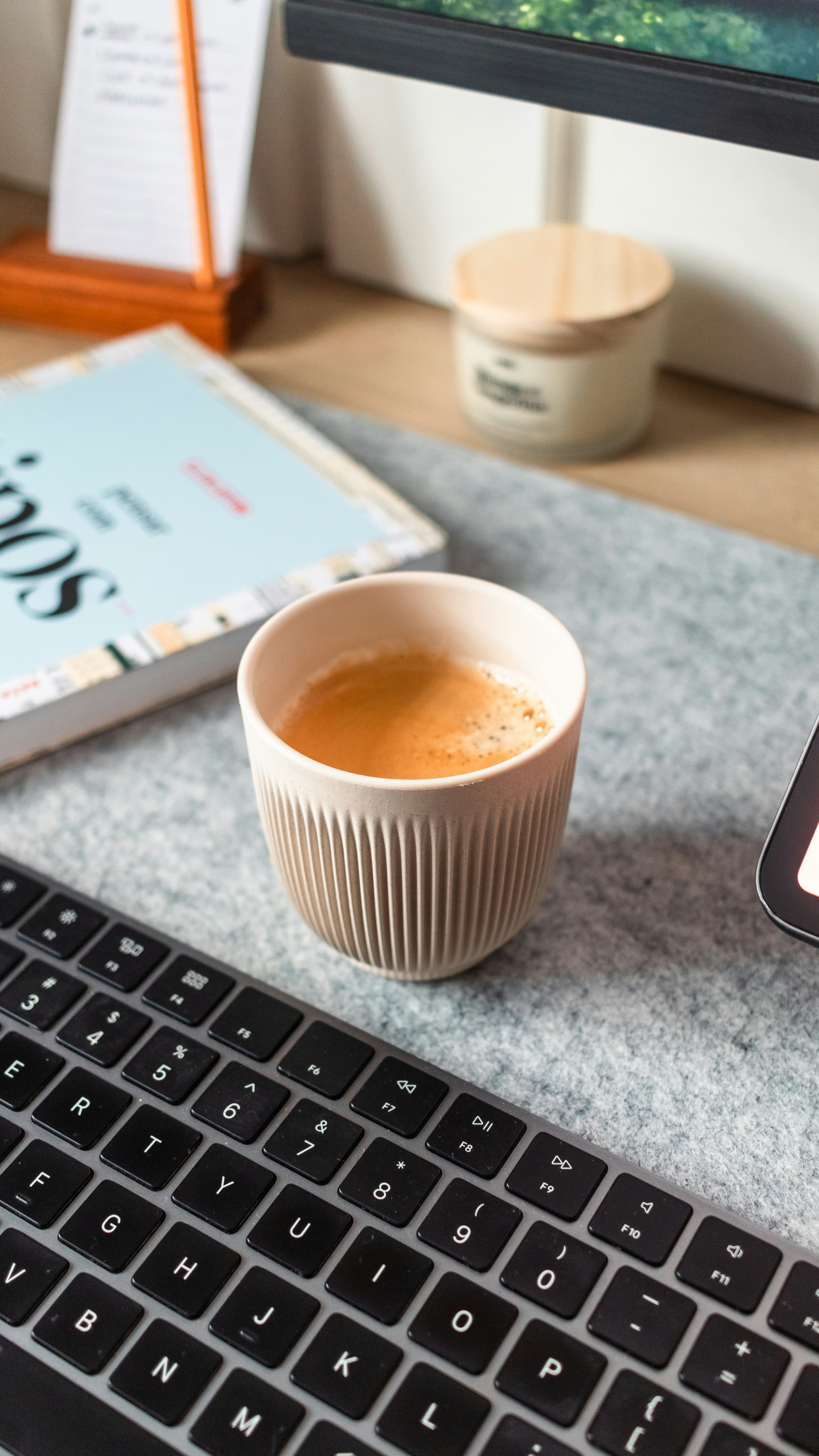 Quiet Morning Brew: A Ceramic Cup Graces a Laptop Workspace
