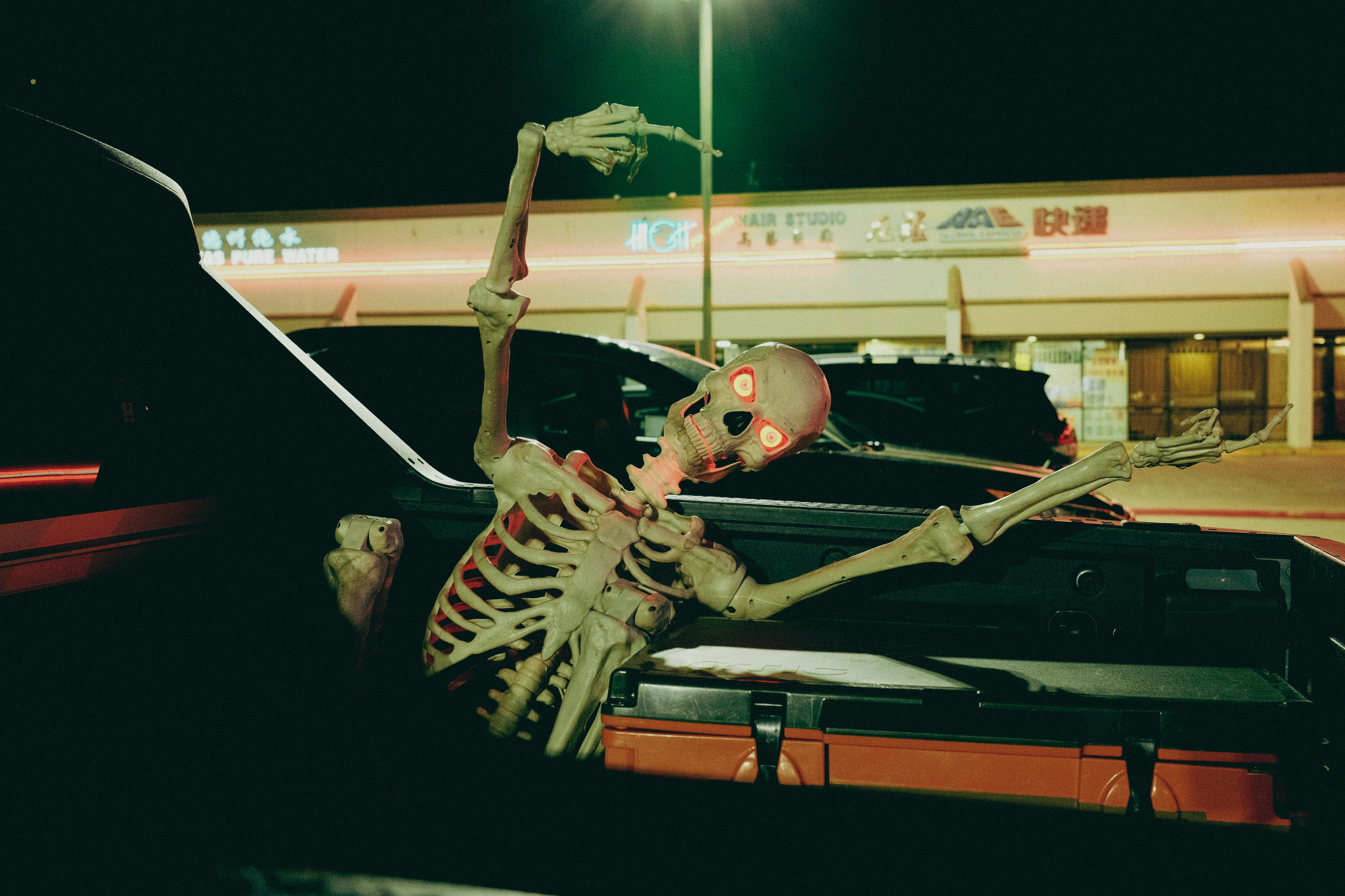 A skeleton is flipping someone off at night. photo – Free Man Image on ...