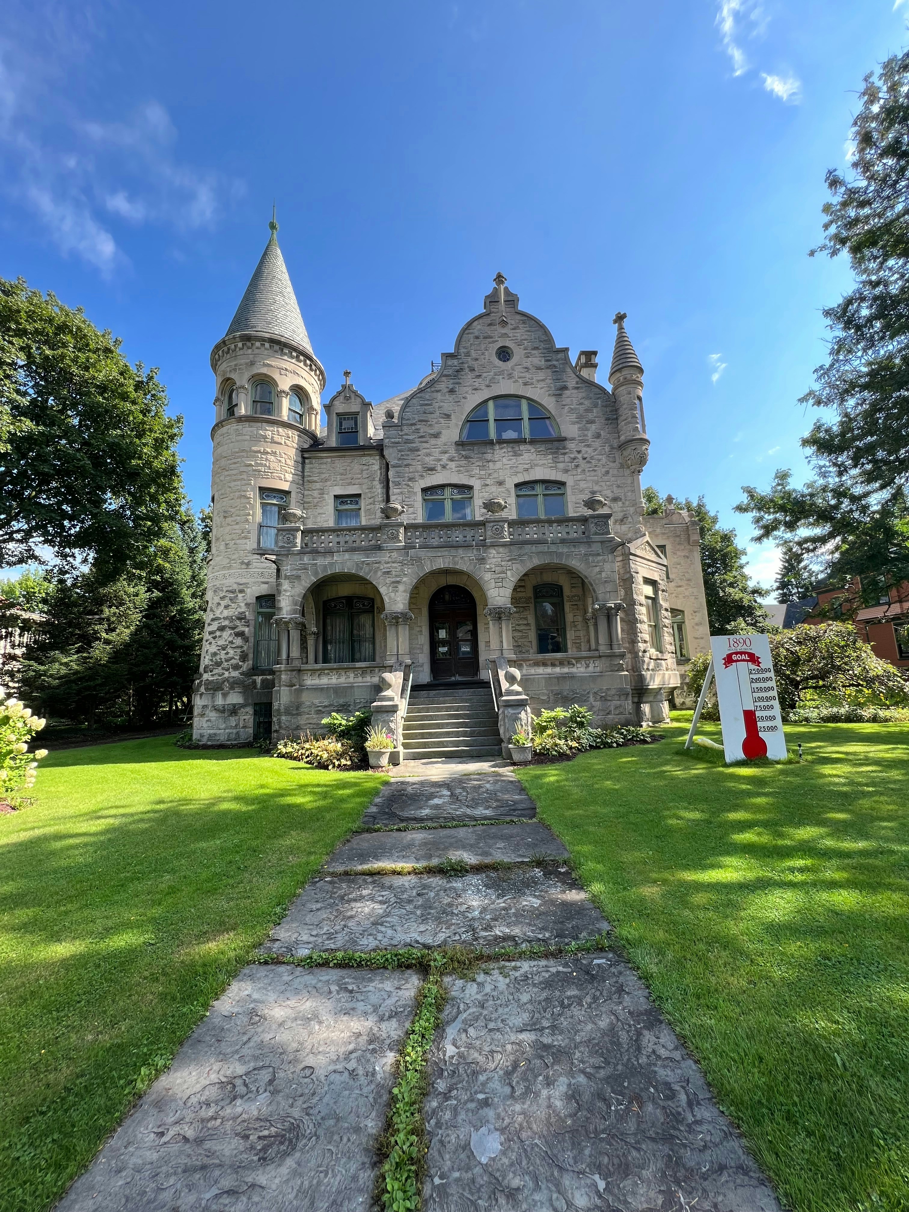 Sunlit Granite Manor: A Gothic Revival Castle at the End of a Stone Path