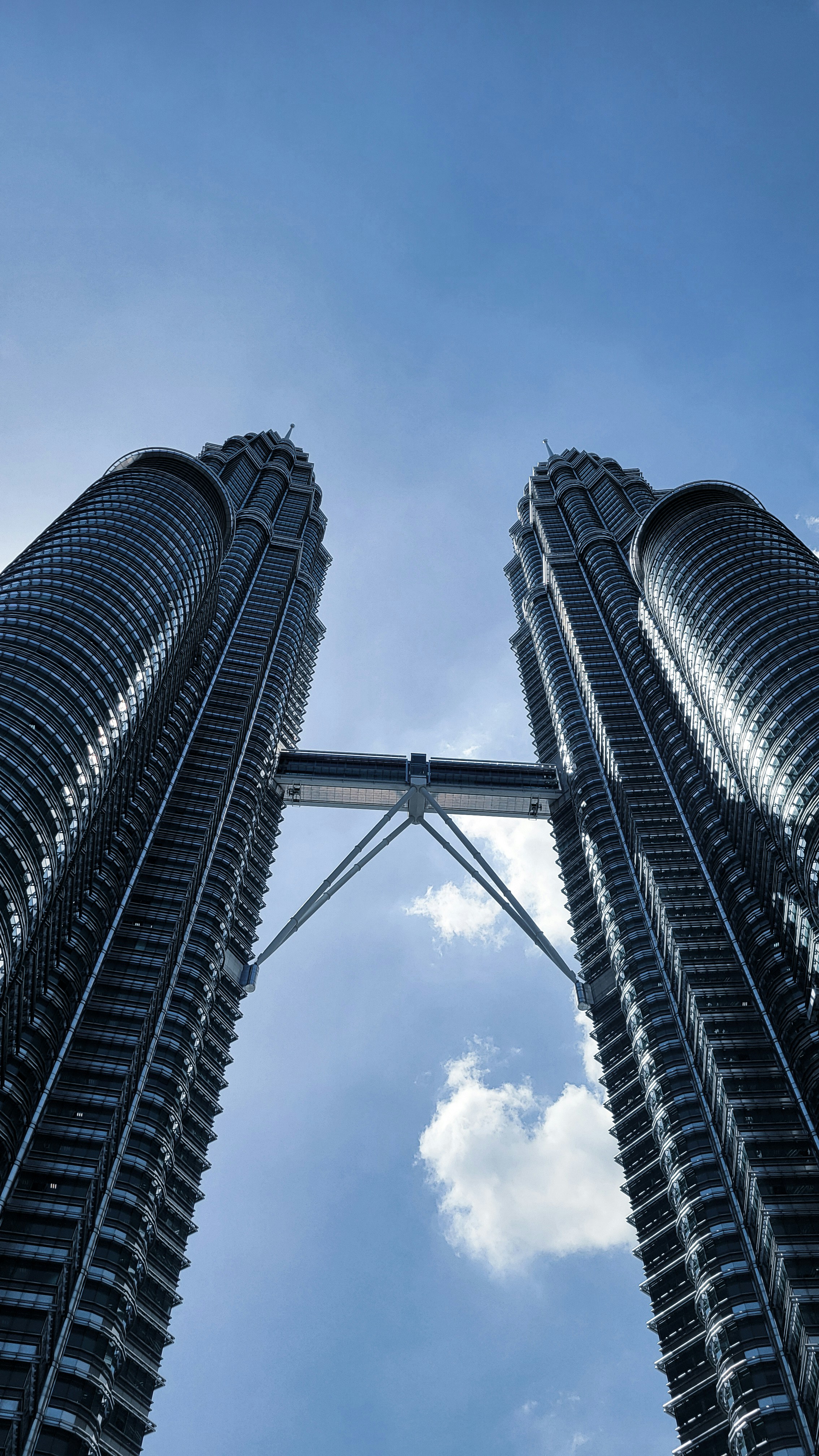 The petronas towers stand tall against the blue sky. photo – Free ...