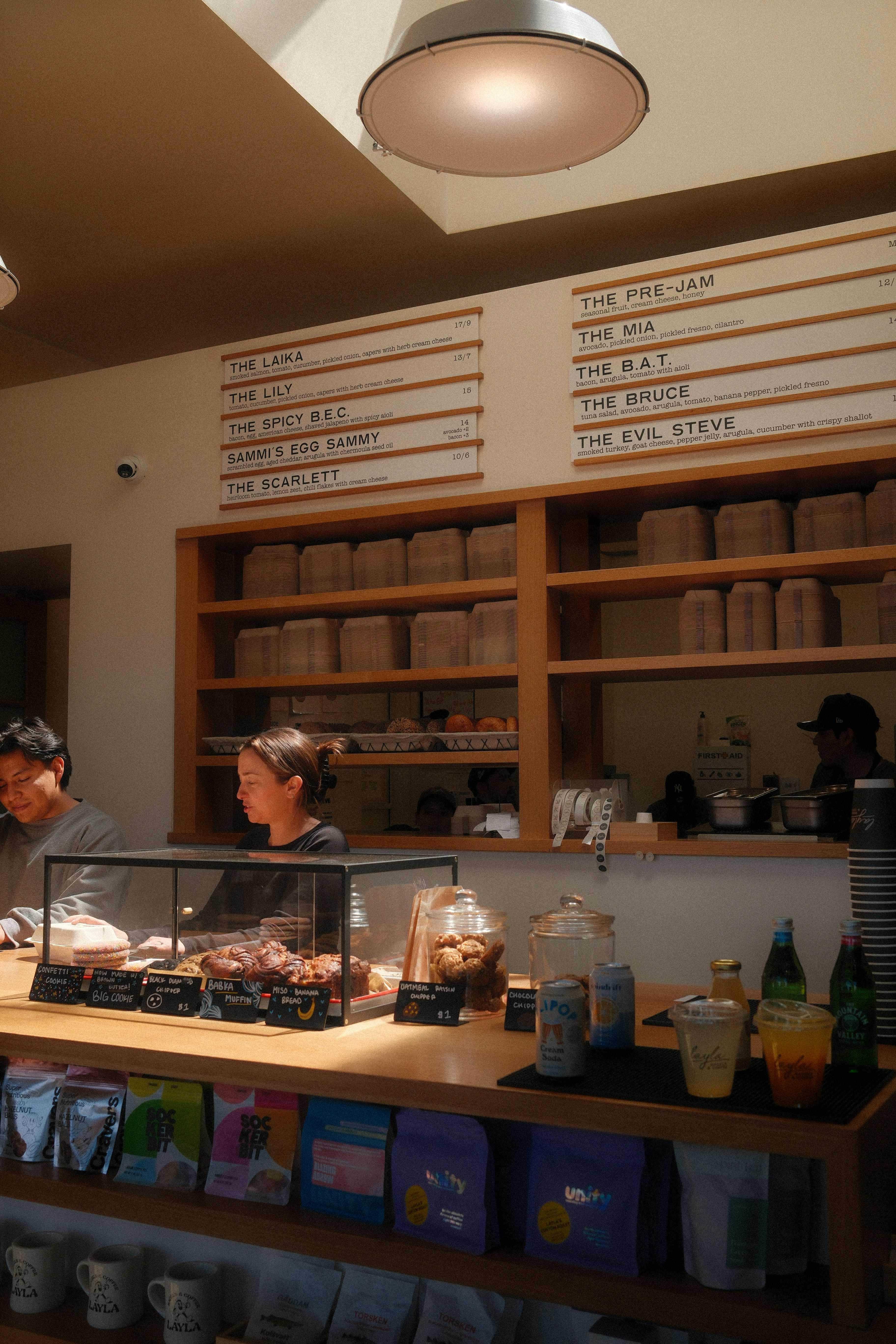 Bagels and coffee | Customers and workers inside a cozy coffee shop.