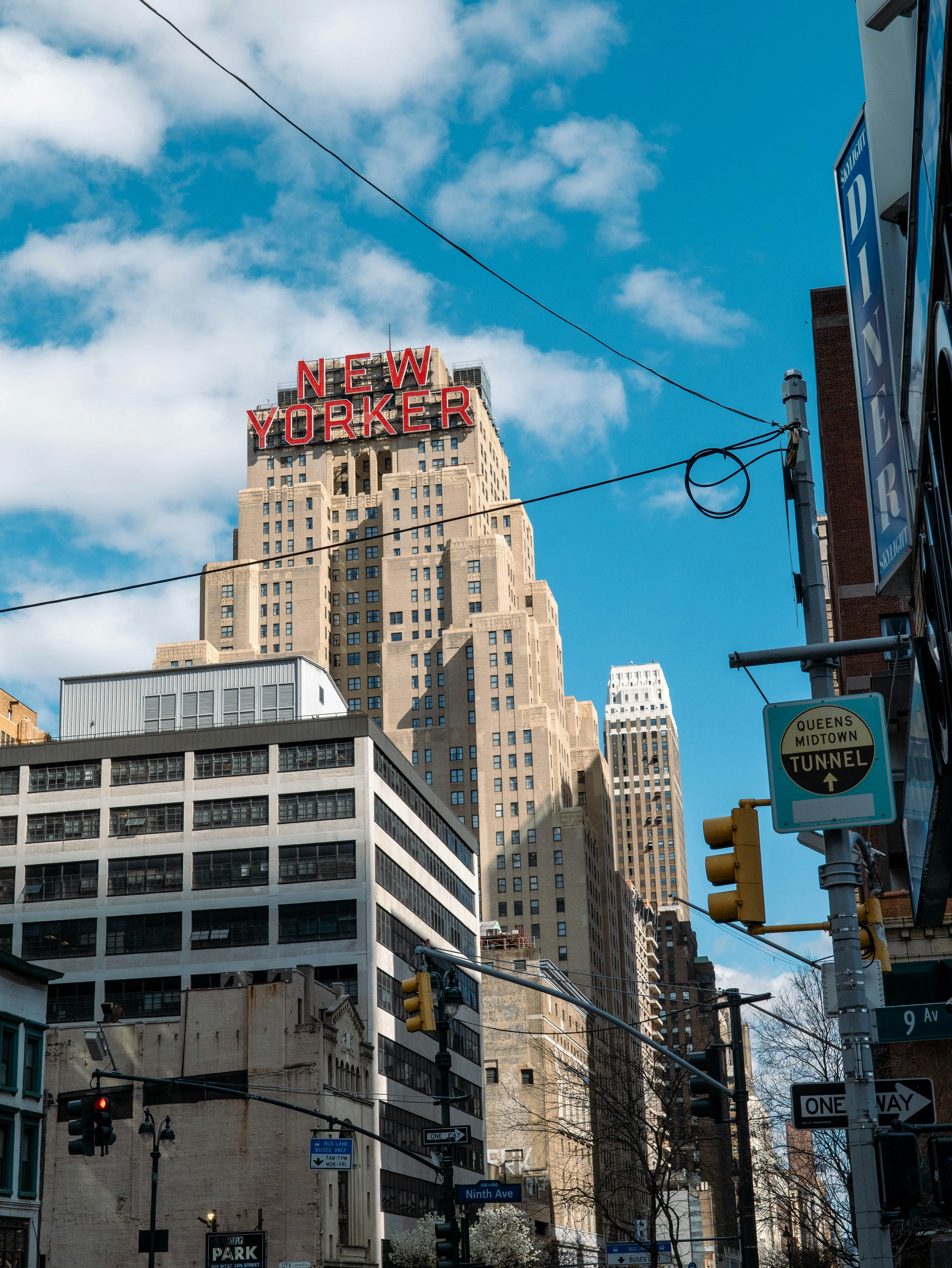 The new yorker hotel stands tall against the blue sky.