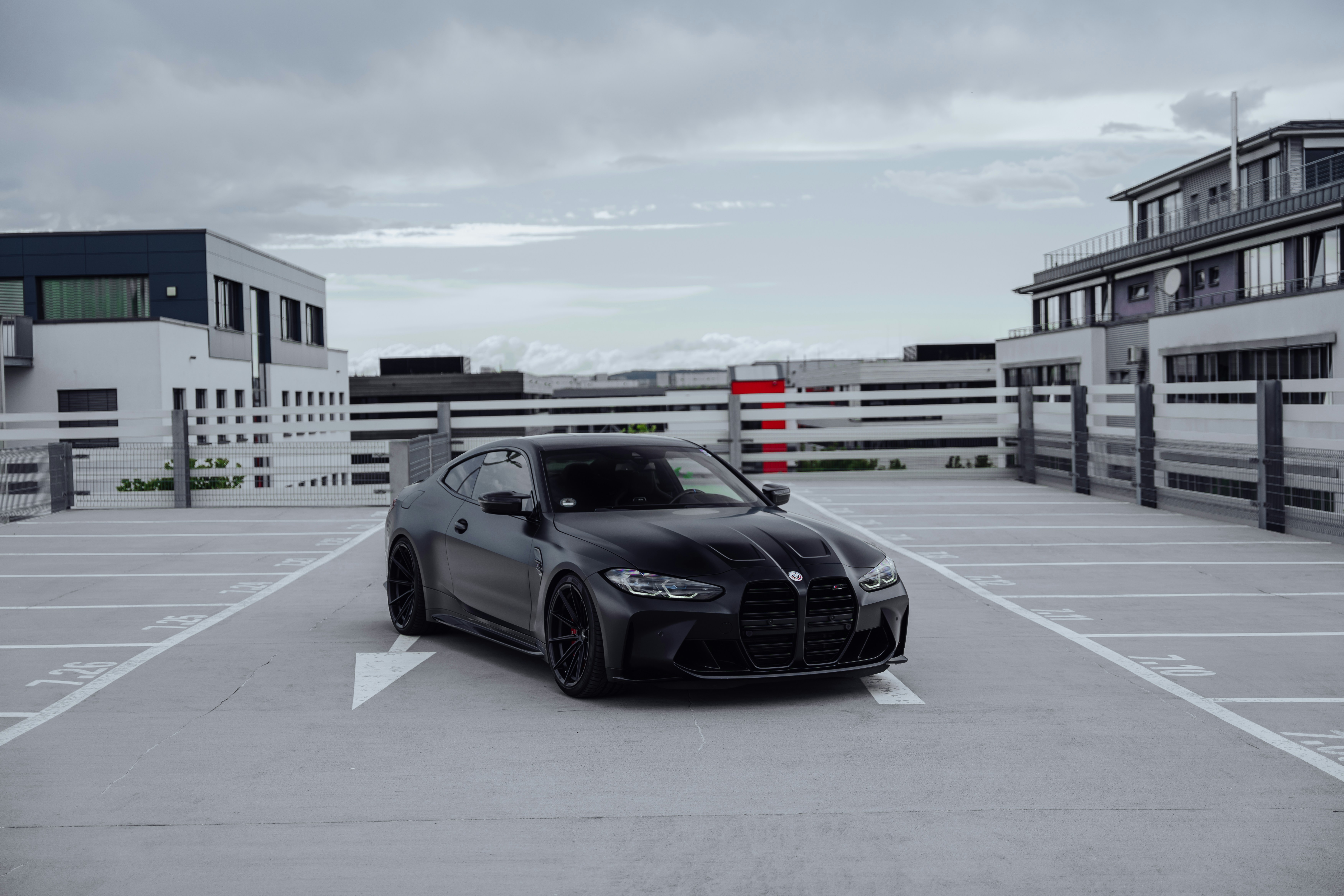 A sleek black car is parked on a rooftop. photo – Free Car Image on ...