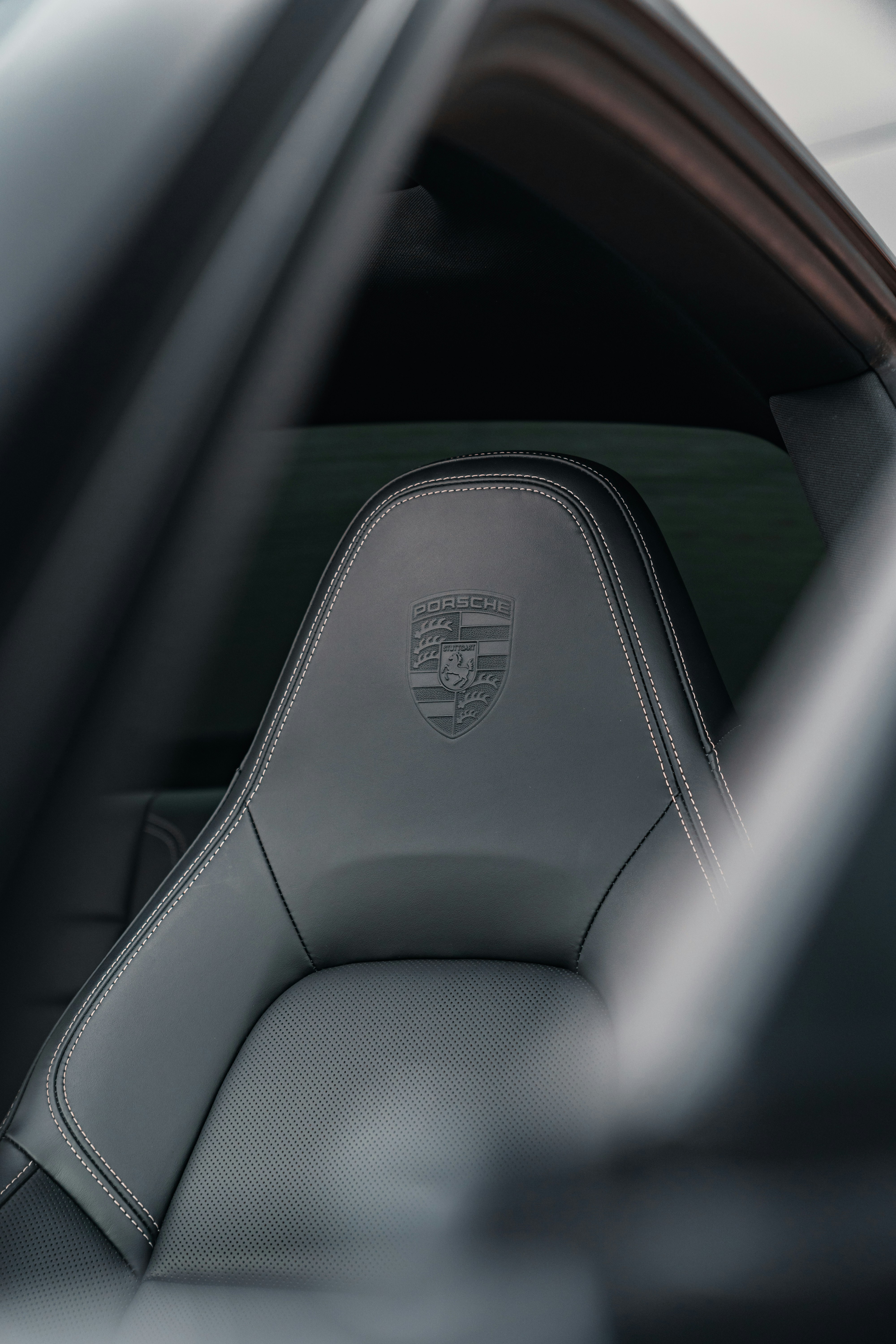 Porsche seat features stitching and logo detail. photo – Free Car Image ...