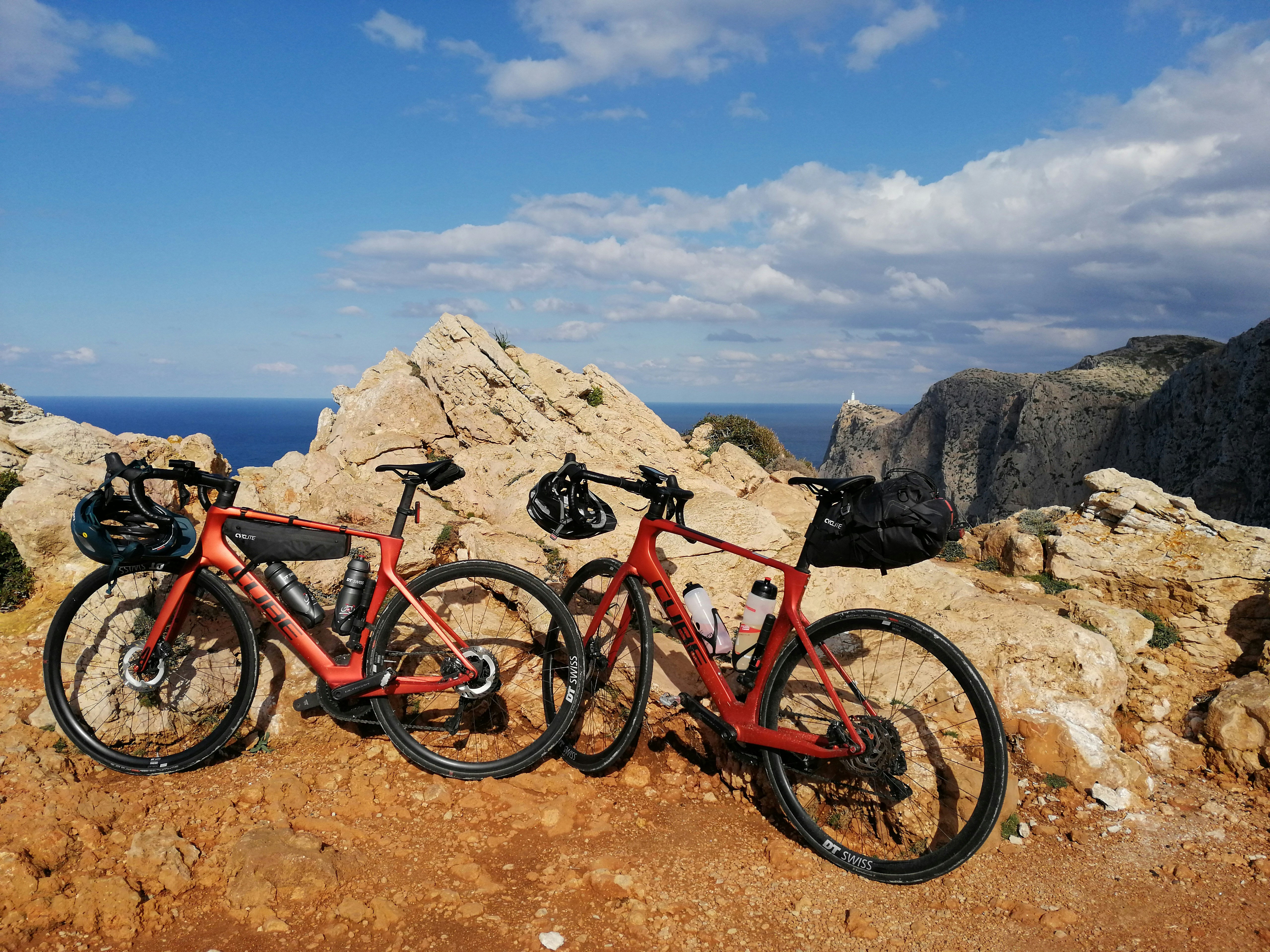 Two bikes stand against a scenic mountain background. photo – Free ...