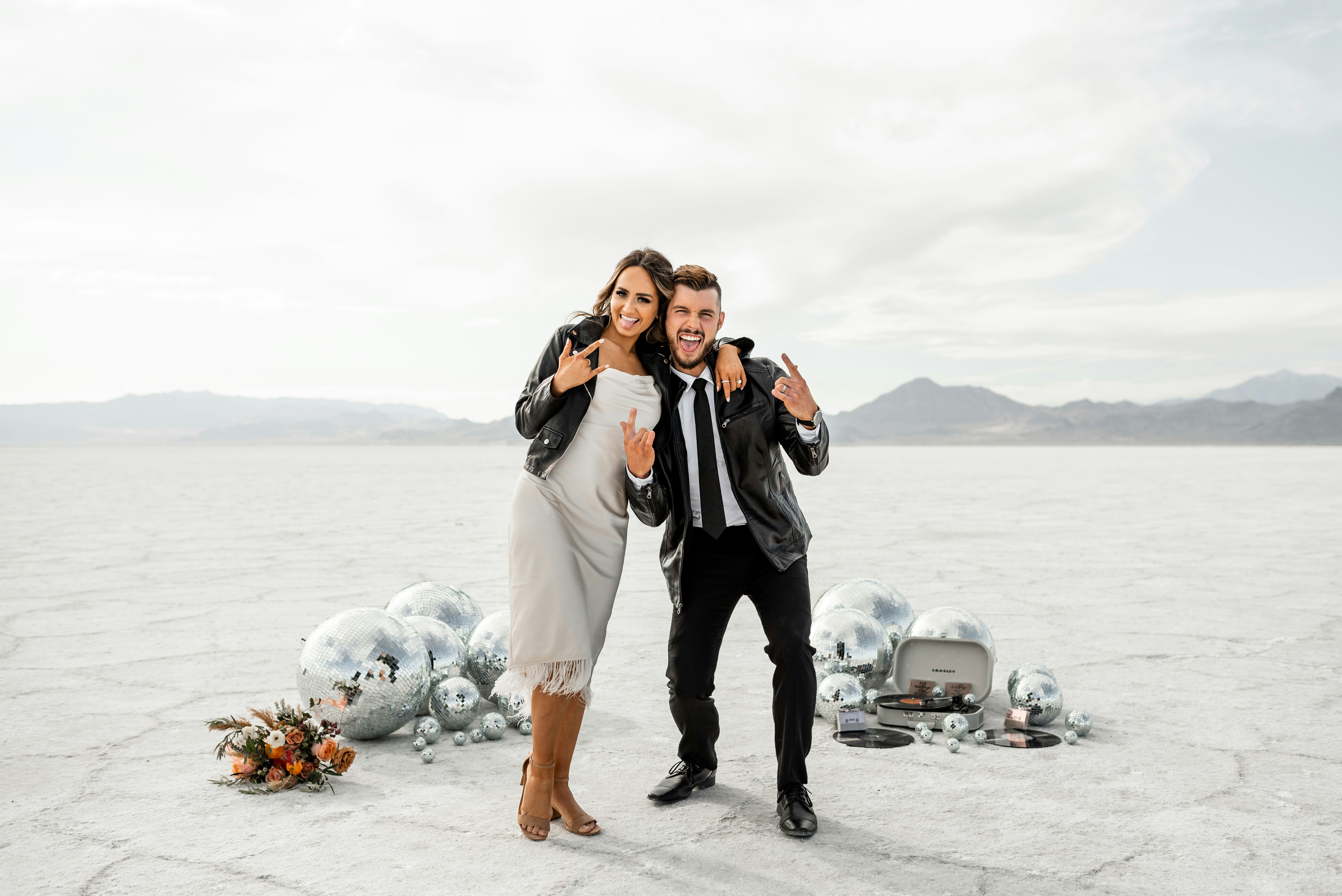 Salt-Flat Celebration: A Playful Couple Among Silver Orbs